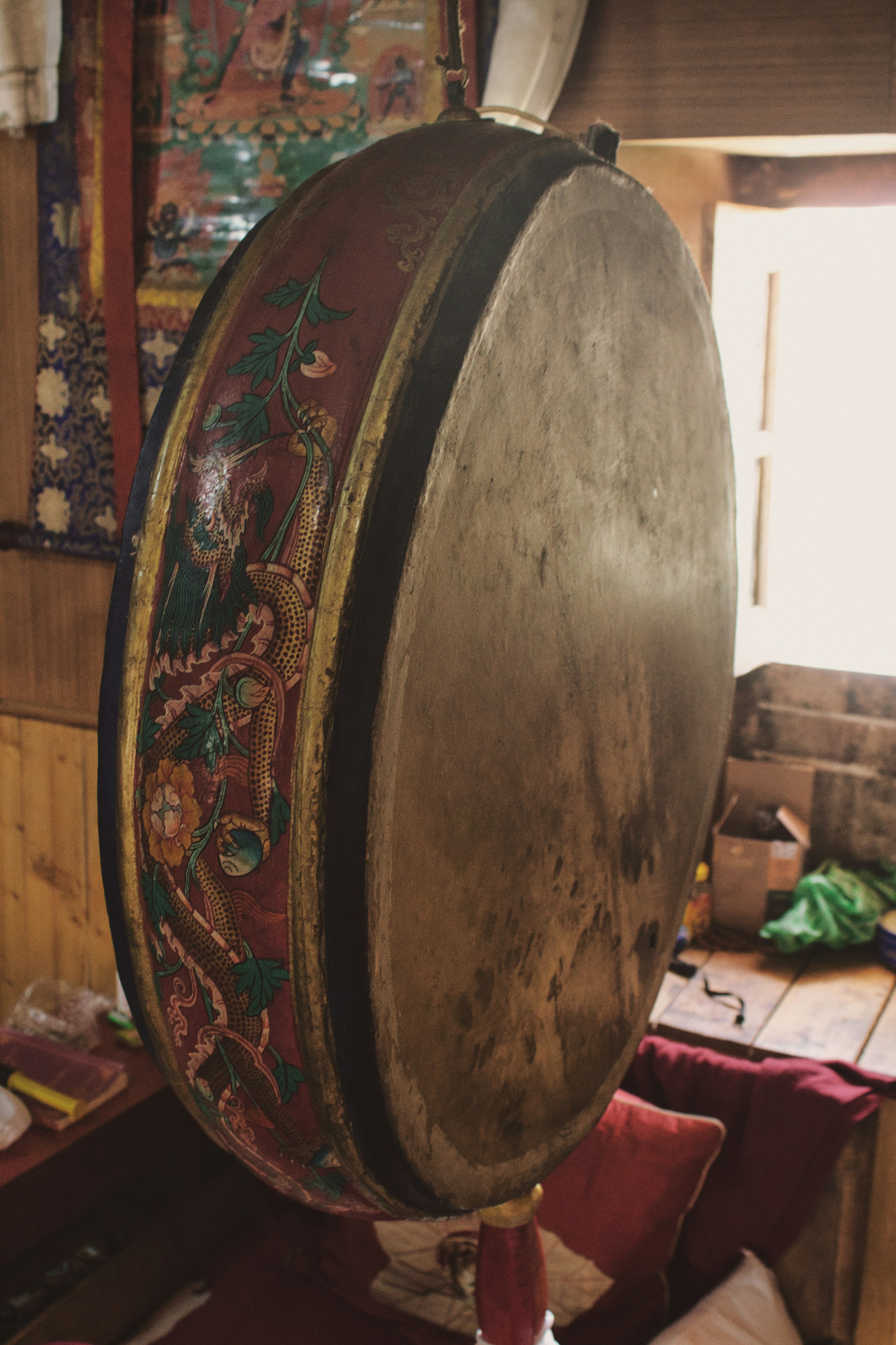 Brown wooden round table on red and white floral area rug photo – Free ...