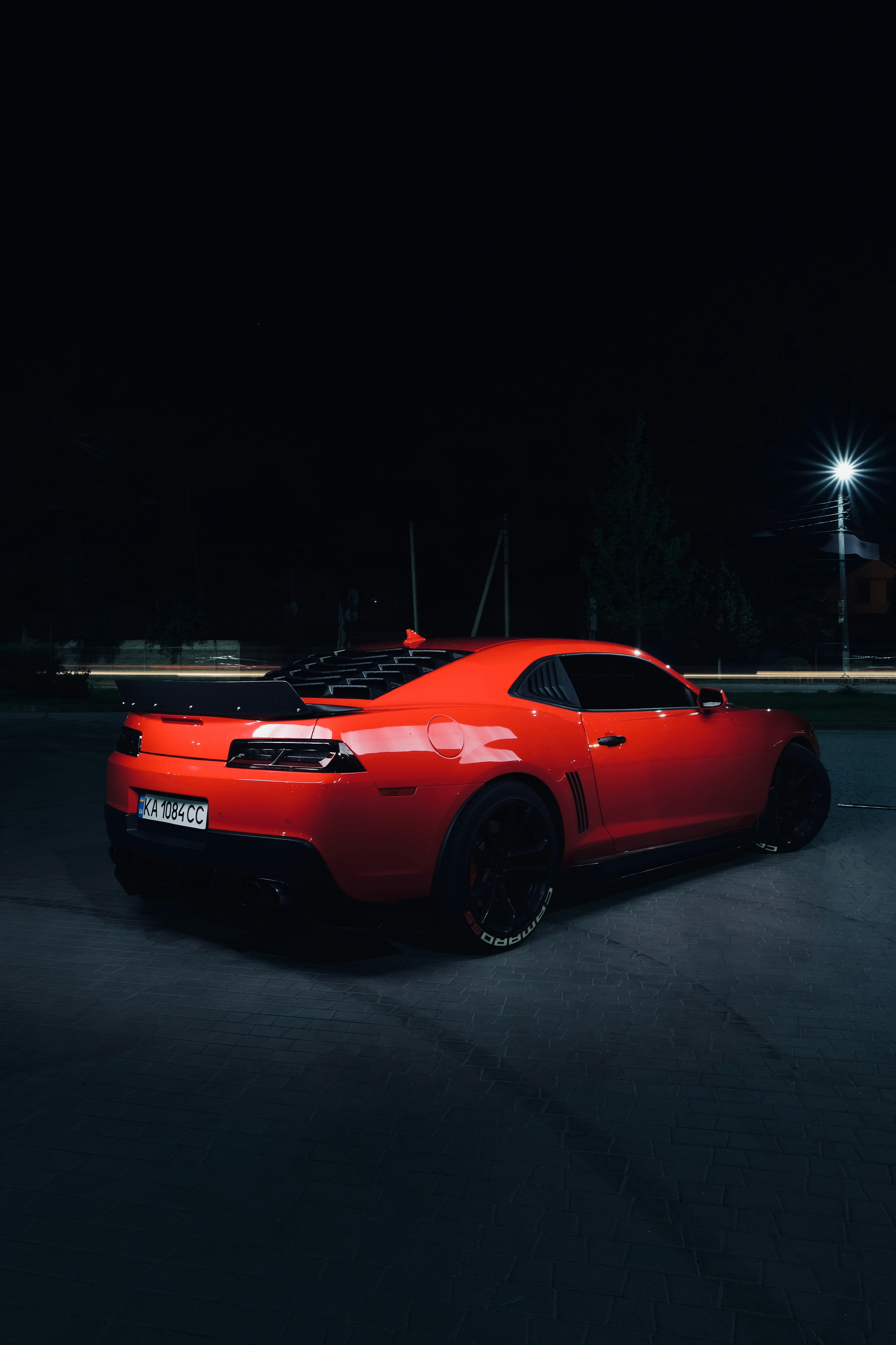 Red chevrolet camaro on road during night time photo – Free Night city ...