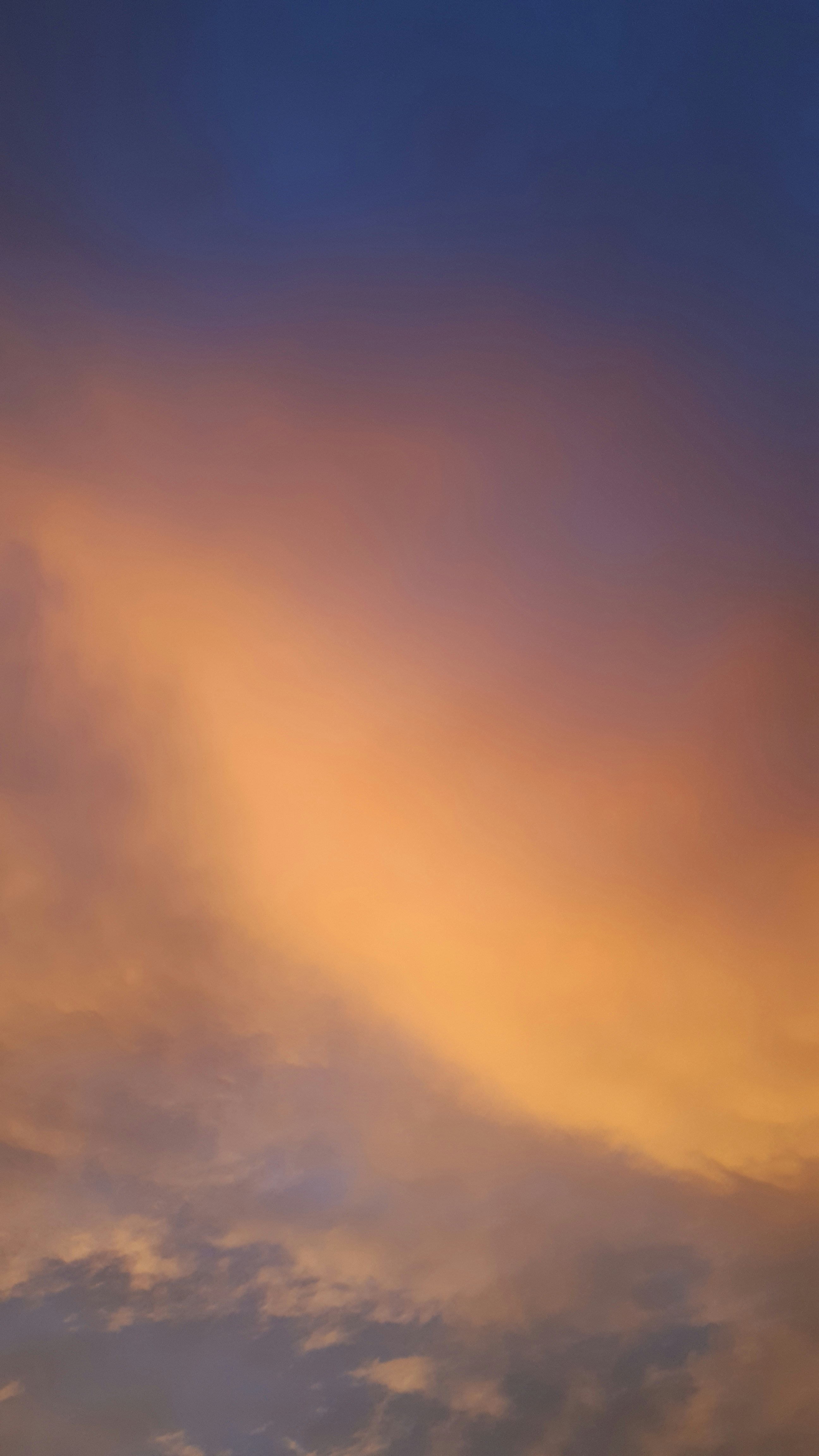 A gradient sky transitioning from deep blue to soft orange hues, evoking a serene evening atmosphere.