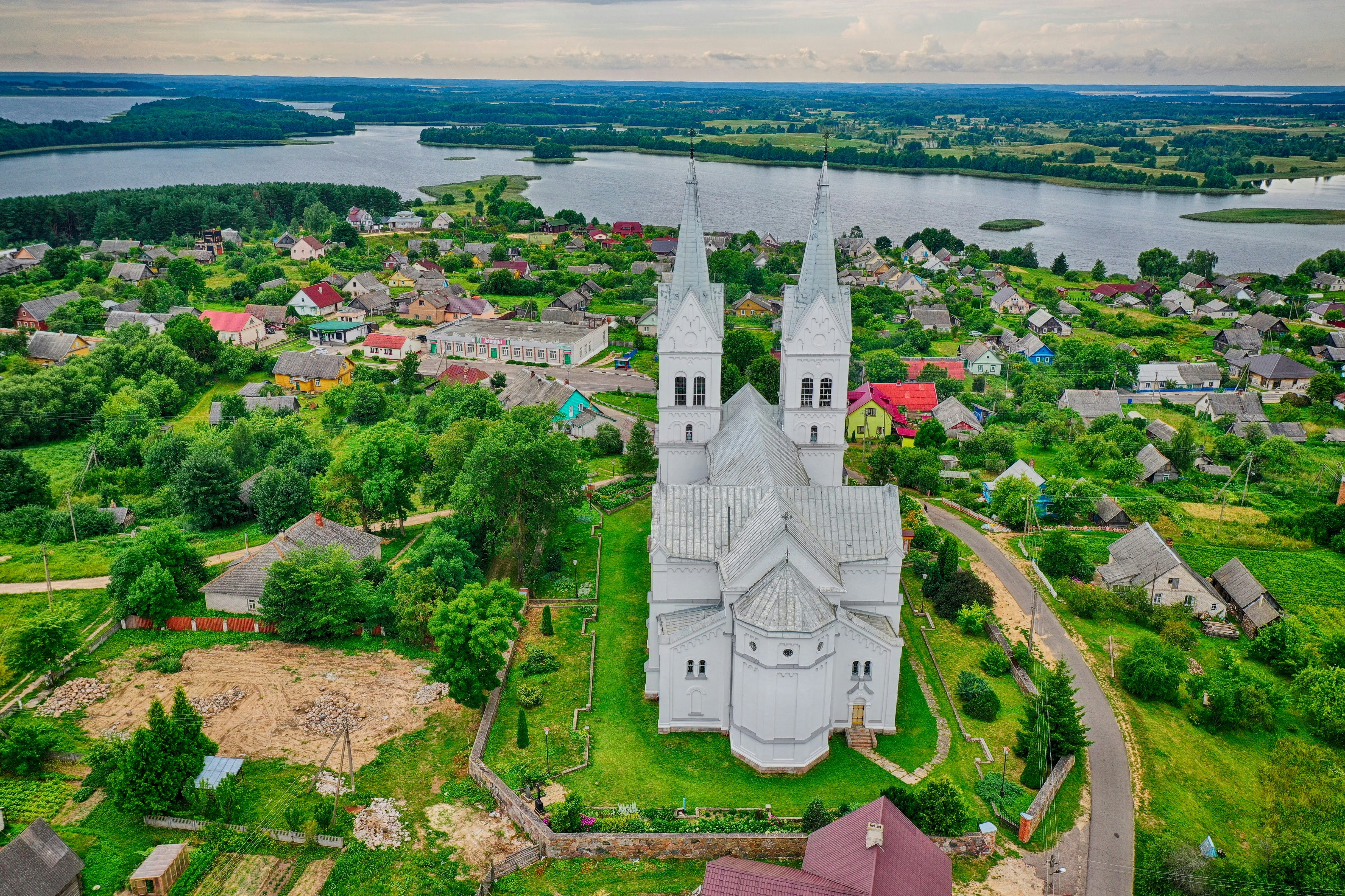 White Gothic Cathedral Surrounded by a Green Village