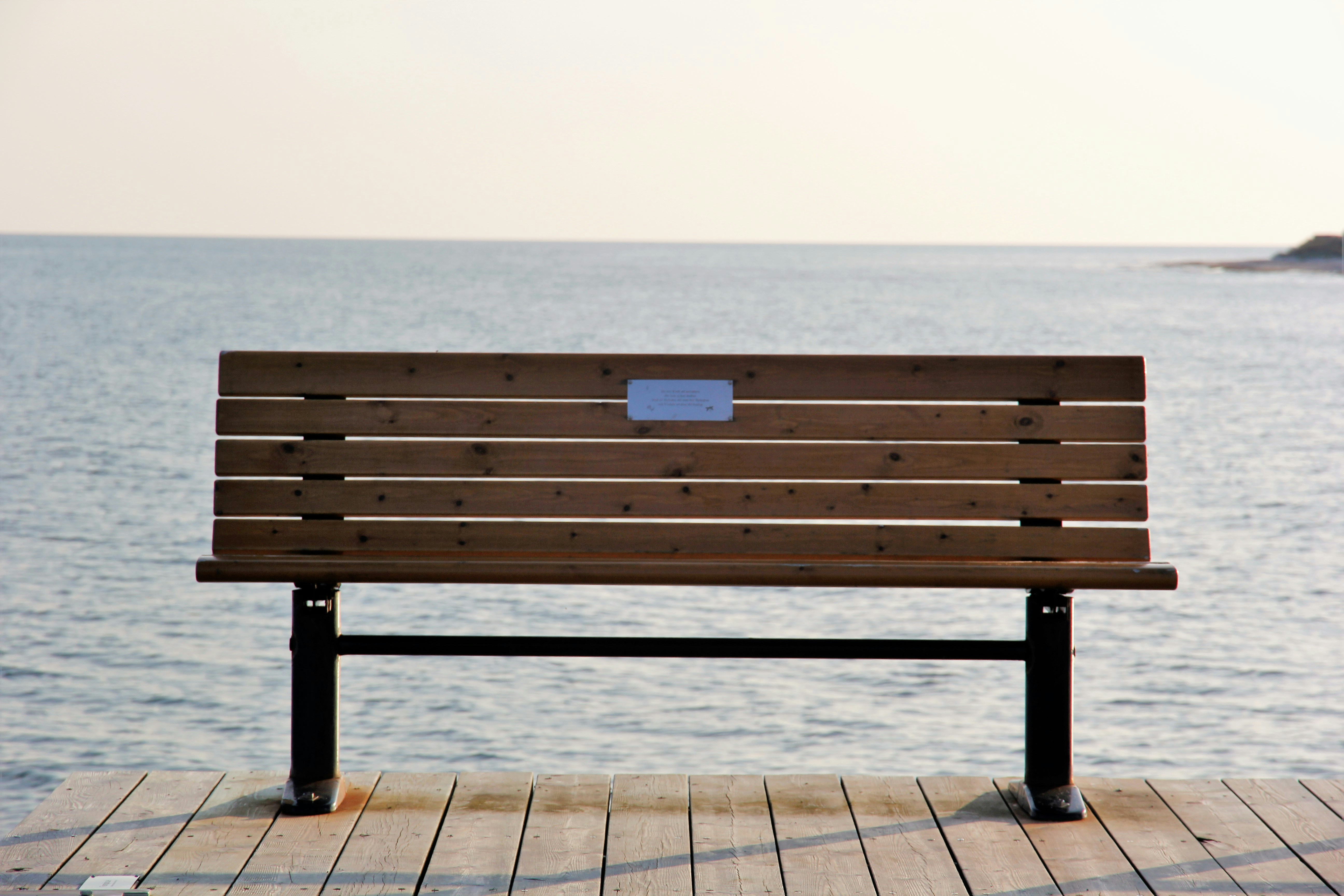 brown wooden bench on dock during daytime
