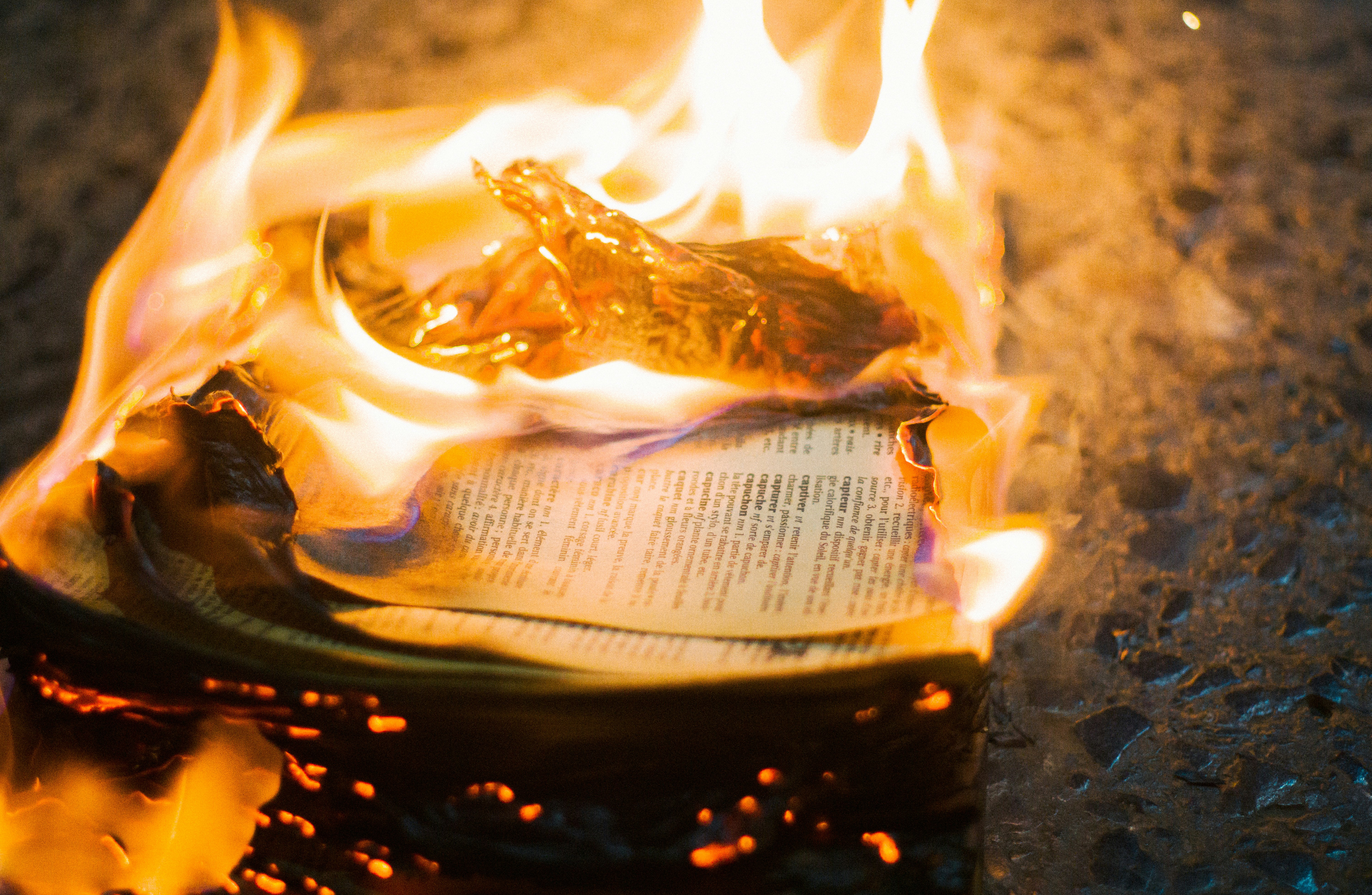 Flames Consume a Tattered Page: A Close-Up of Burning Paper as Night Burns Away