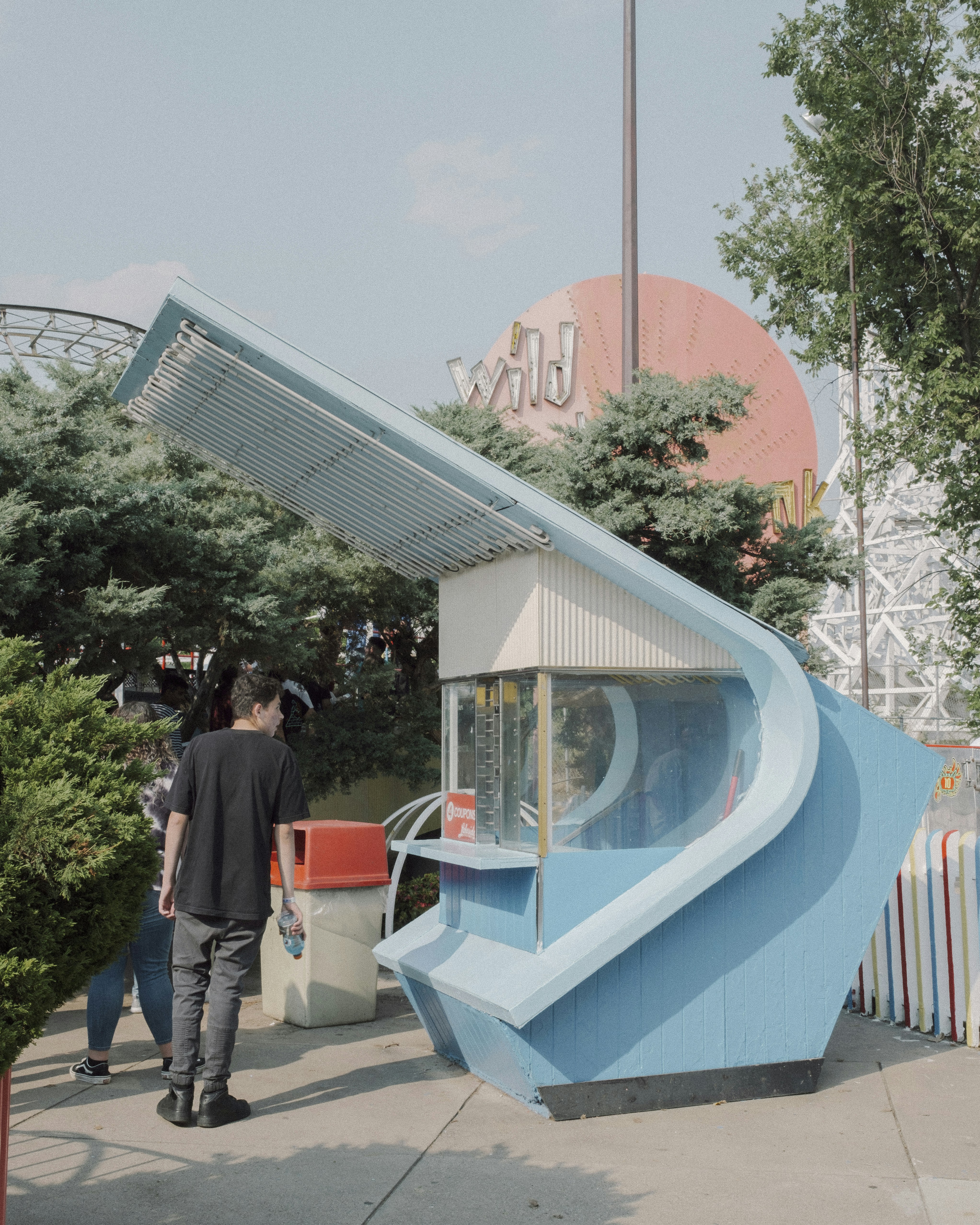 Azure Curve: The Blue Booth Framing a Quiet Park Moment