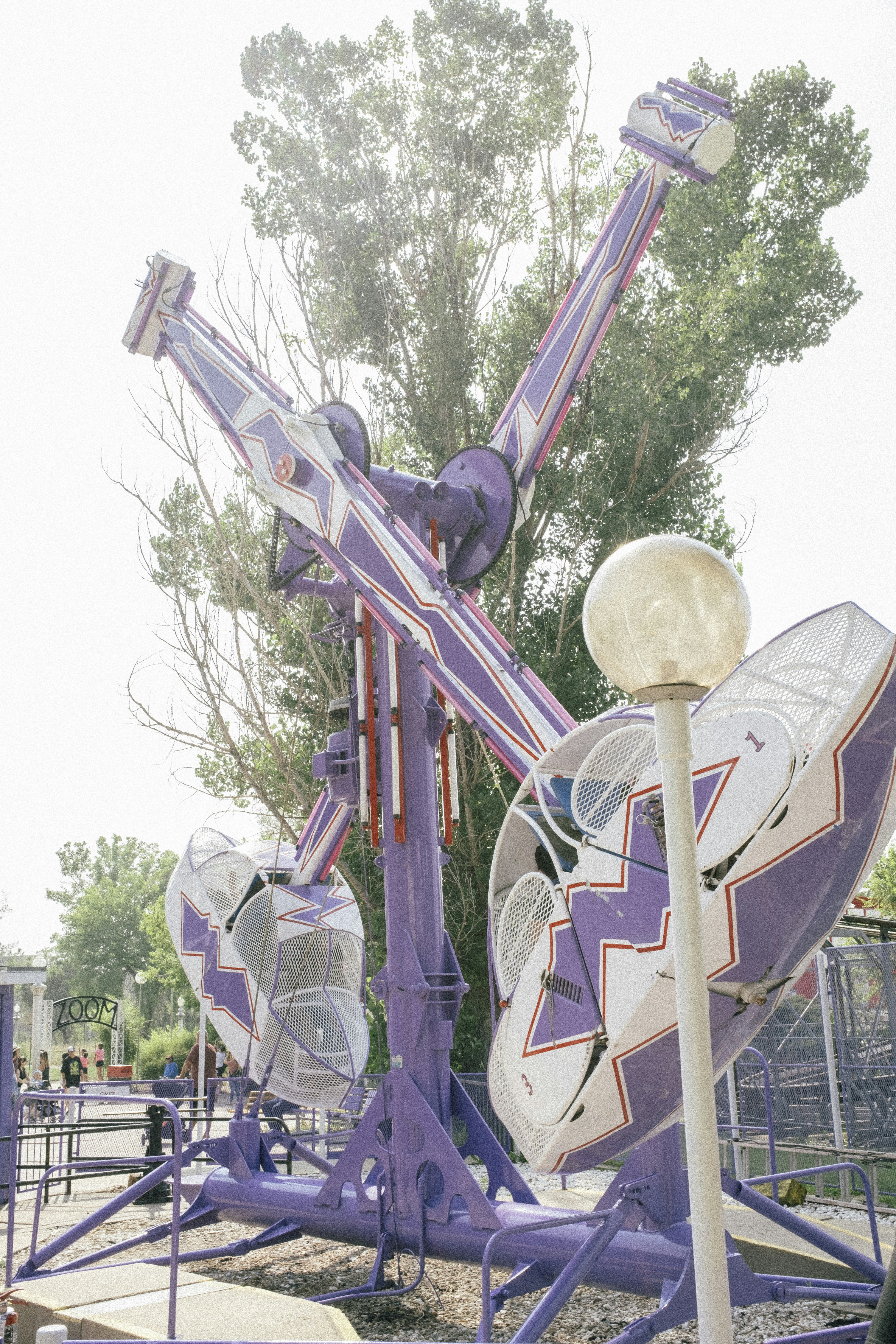 The Violet Spinner: Intersecting Arms in a Quiet Carnival Moment