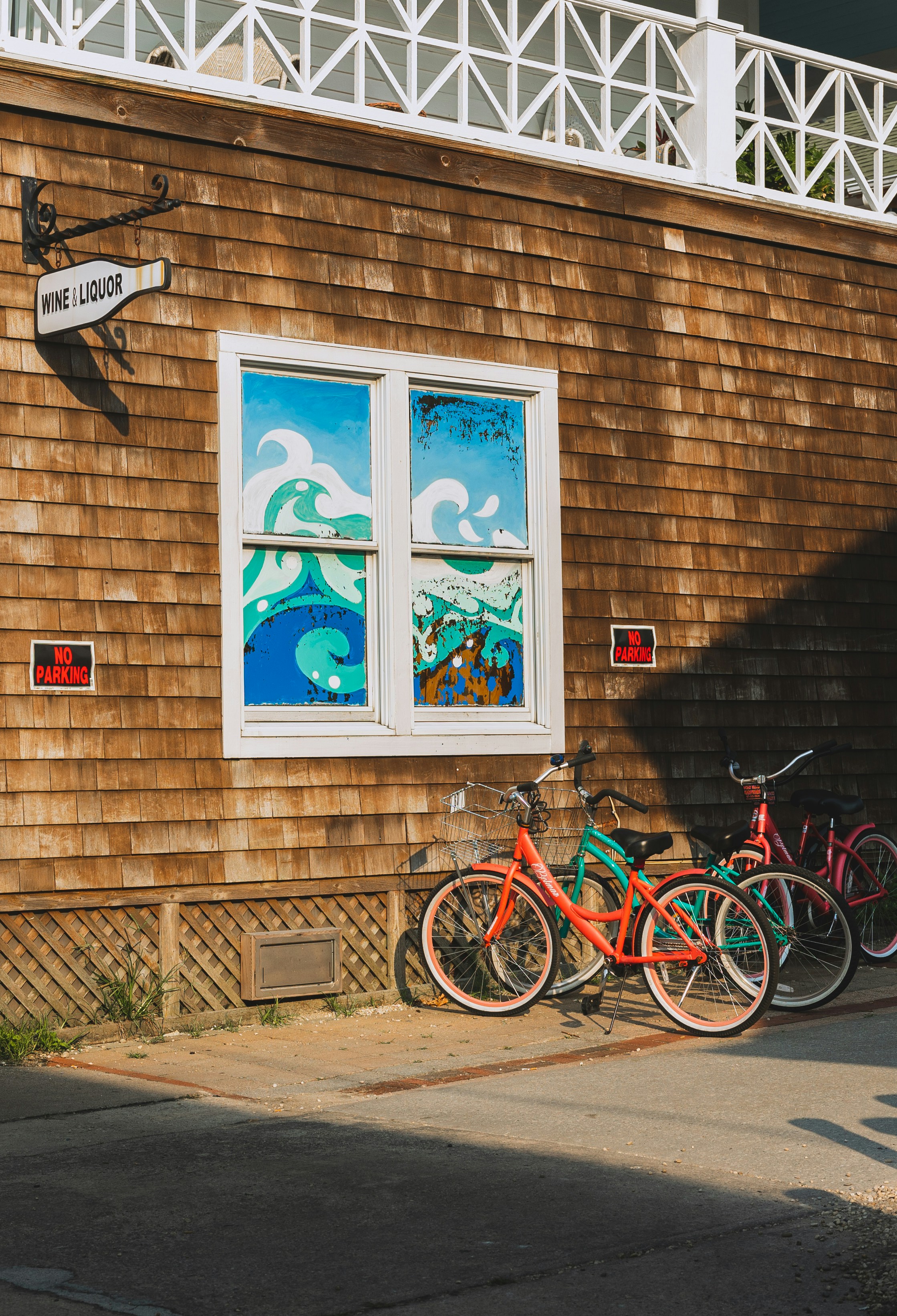 Sunlit Cedar Frontage: mural-window and a row of colorful bikes