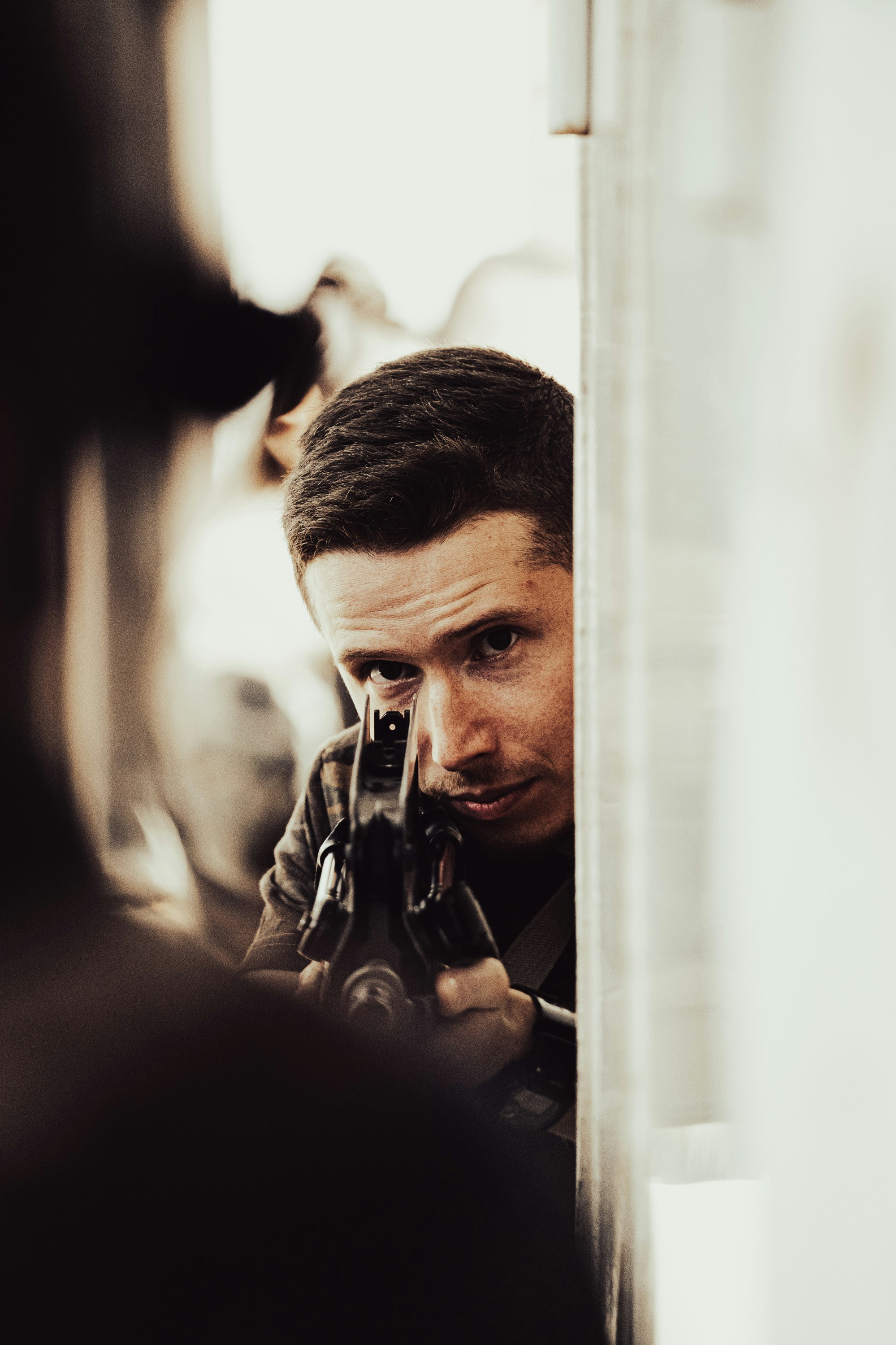 Intercepted Gaze: A Photographer's Quiet Stare Through a Doorframe