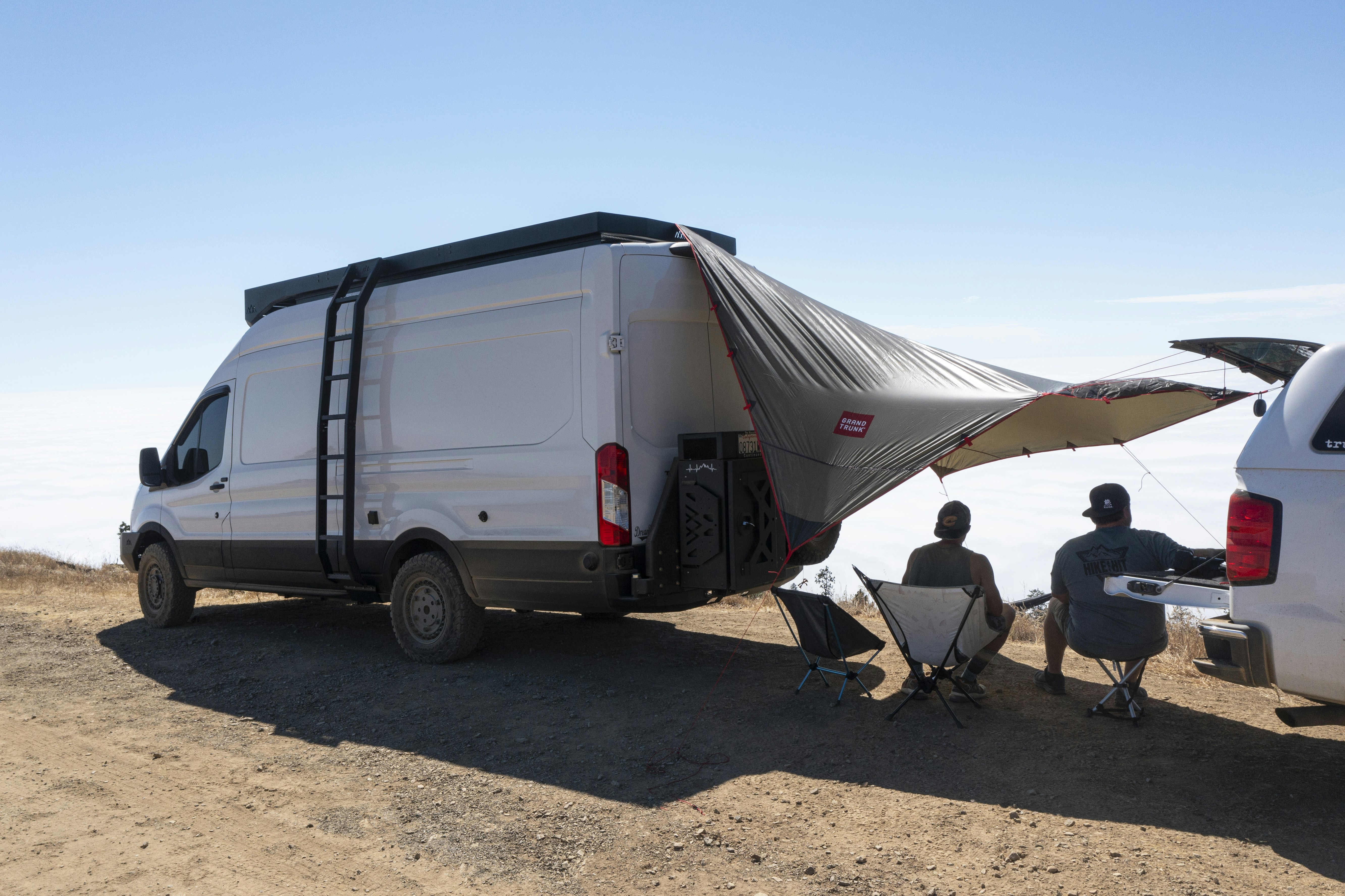 Desert Shelter: White Camper Van Draped in Shade for a Quiet Outdoor Retreat