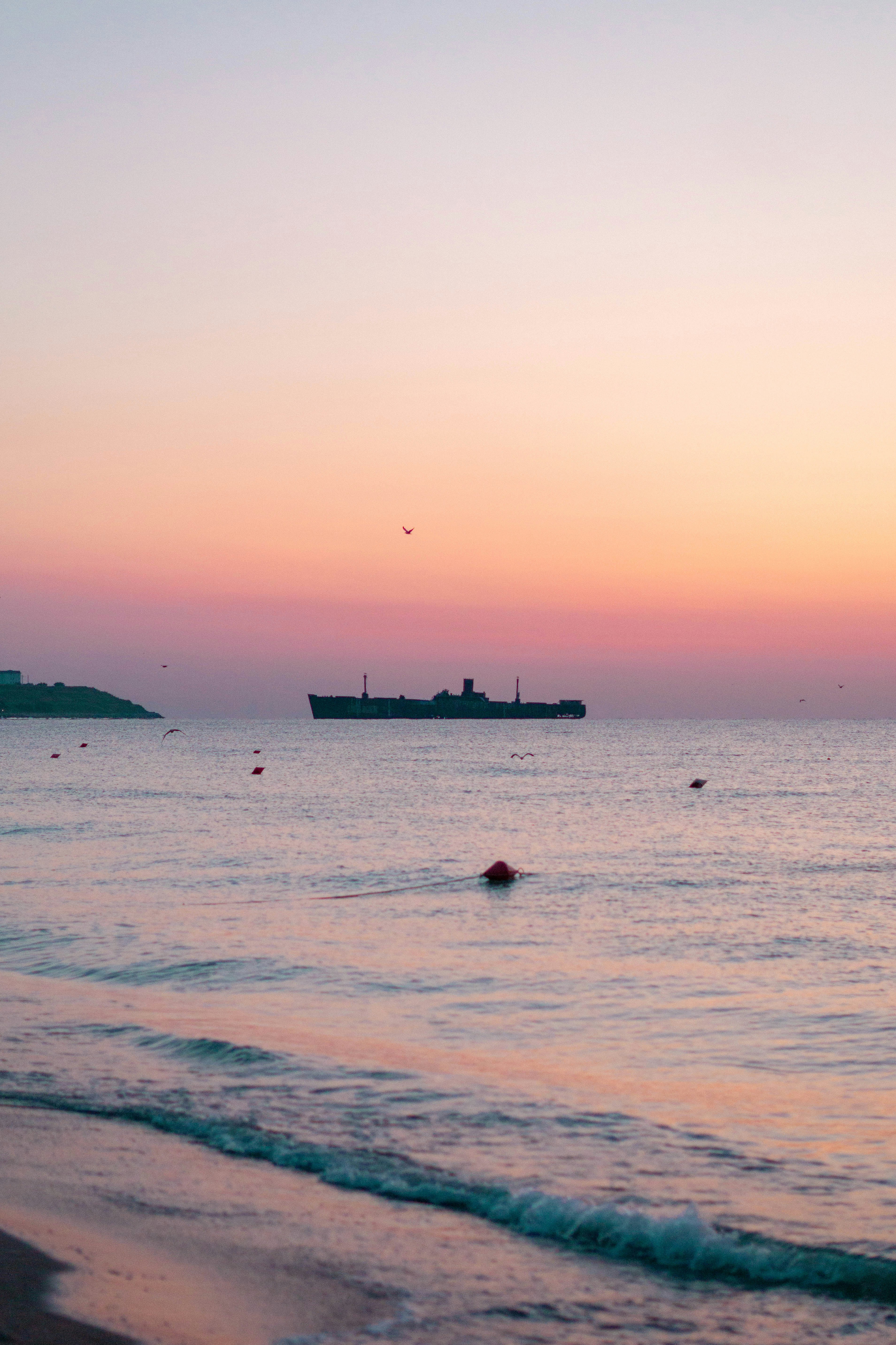 Pastel Horizon: Cargo Ship Against a Velvet Sunset
