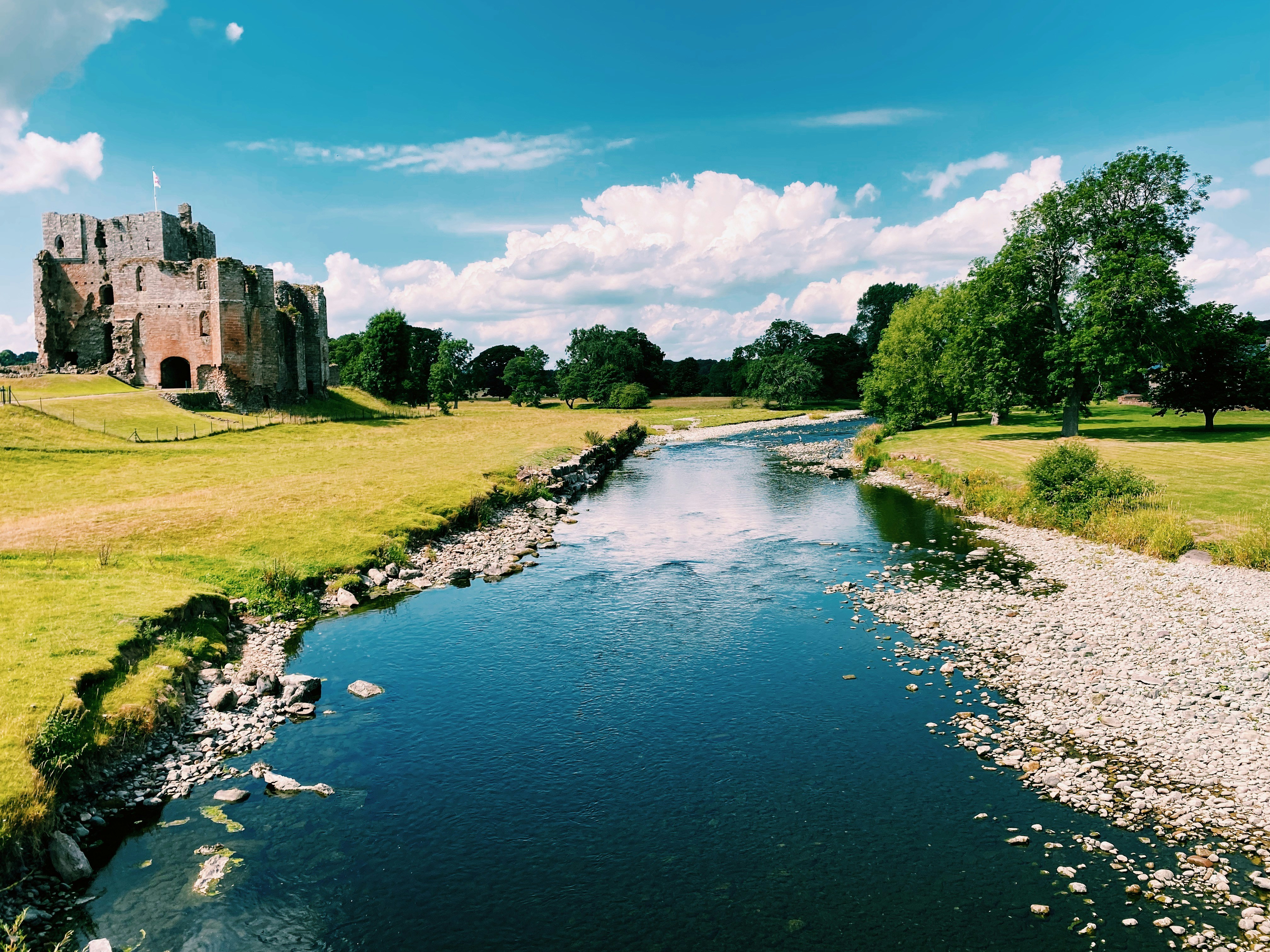 Ruined Fortress Framed by a Meandering River in Bright Daylight