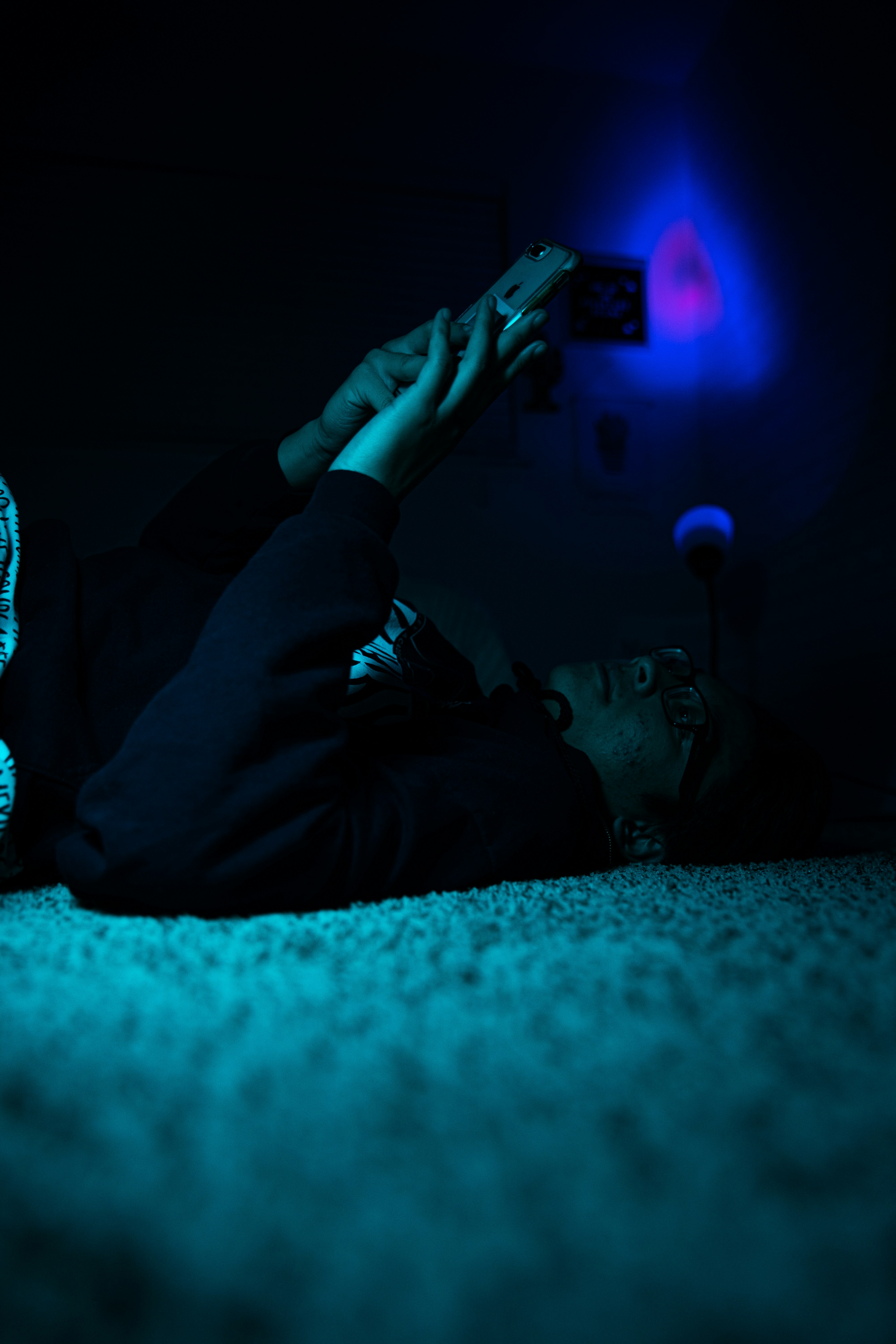 man in black pants lying on floor