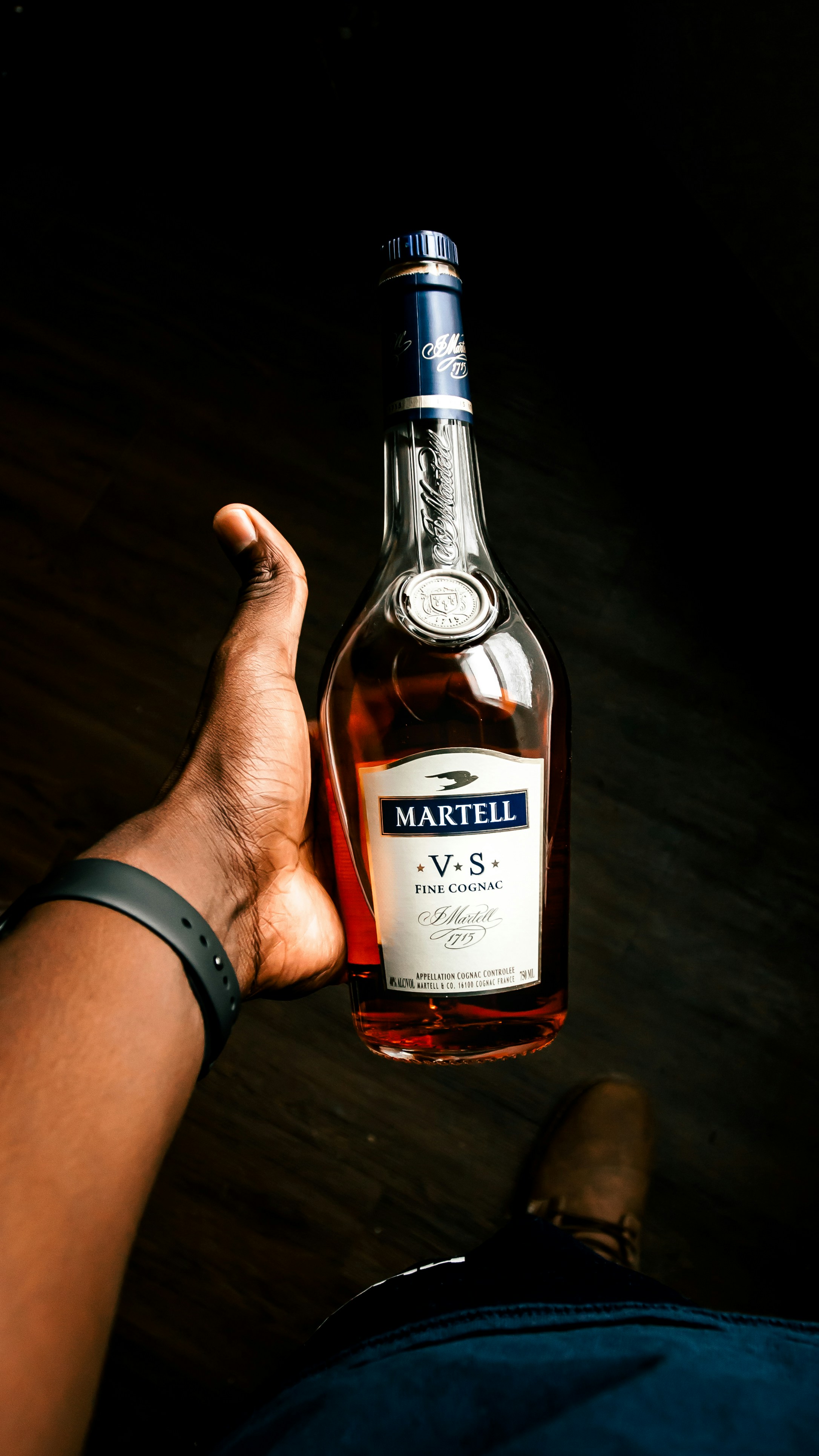 person holding white labeled bottle