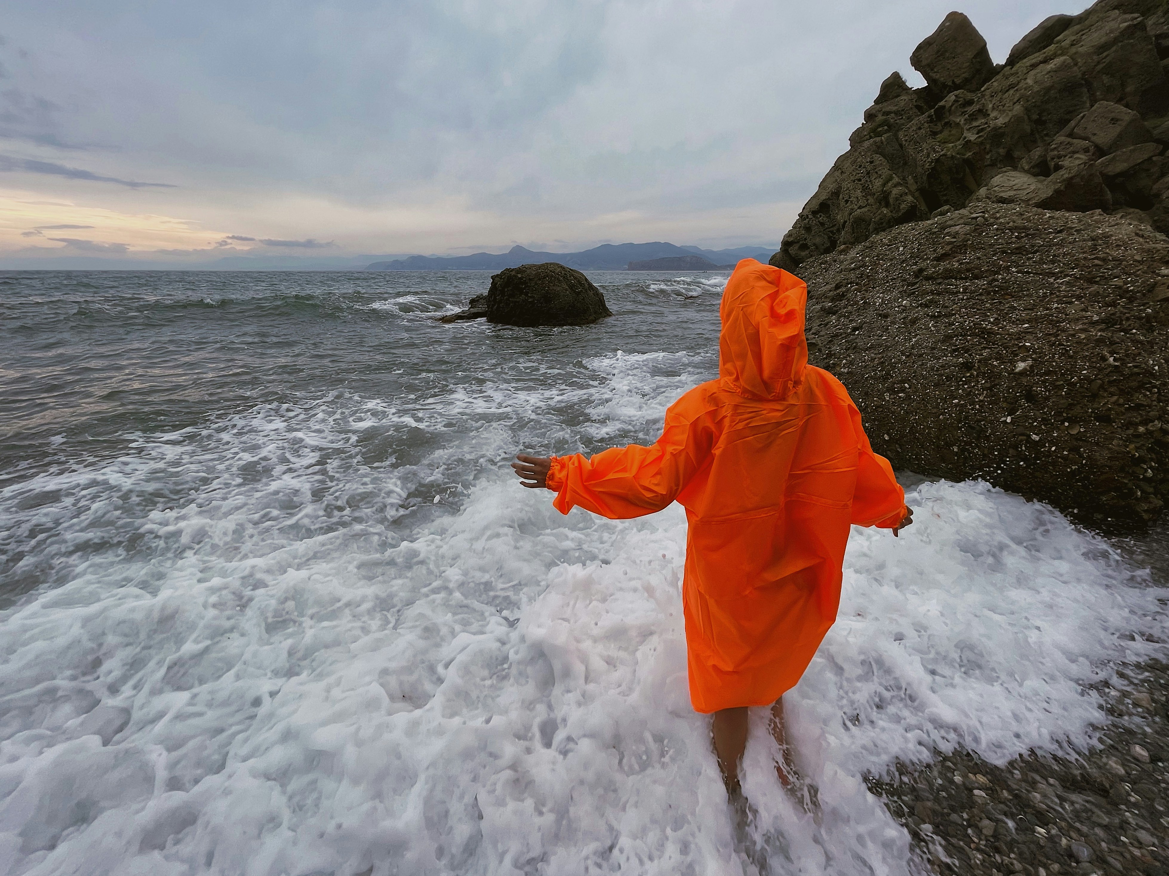 Orange Jacket in the Roaring Tide: Seaside Escape