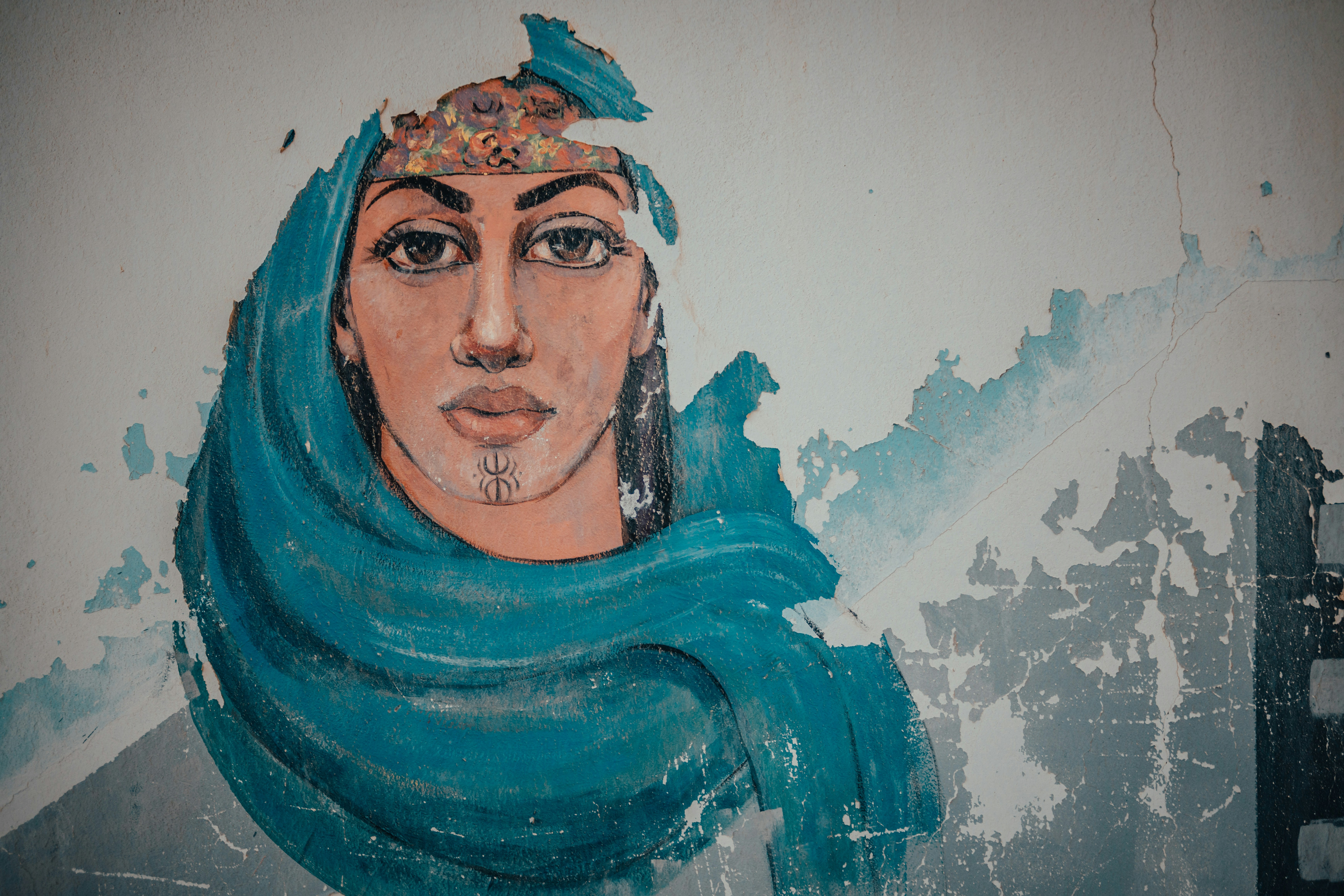 Turquoise Veil: Portrait Emerges from a Weathered Wall