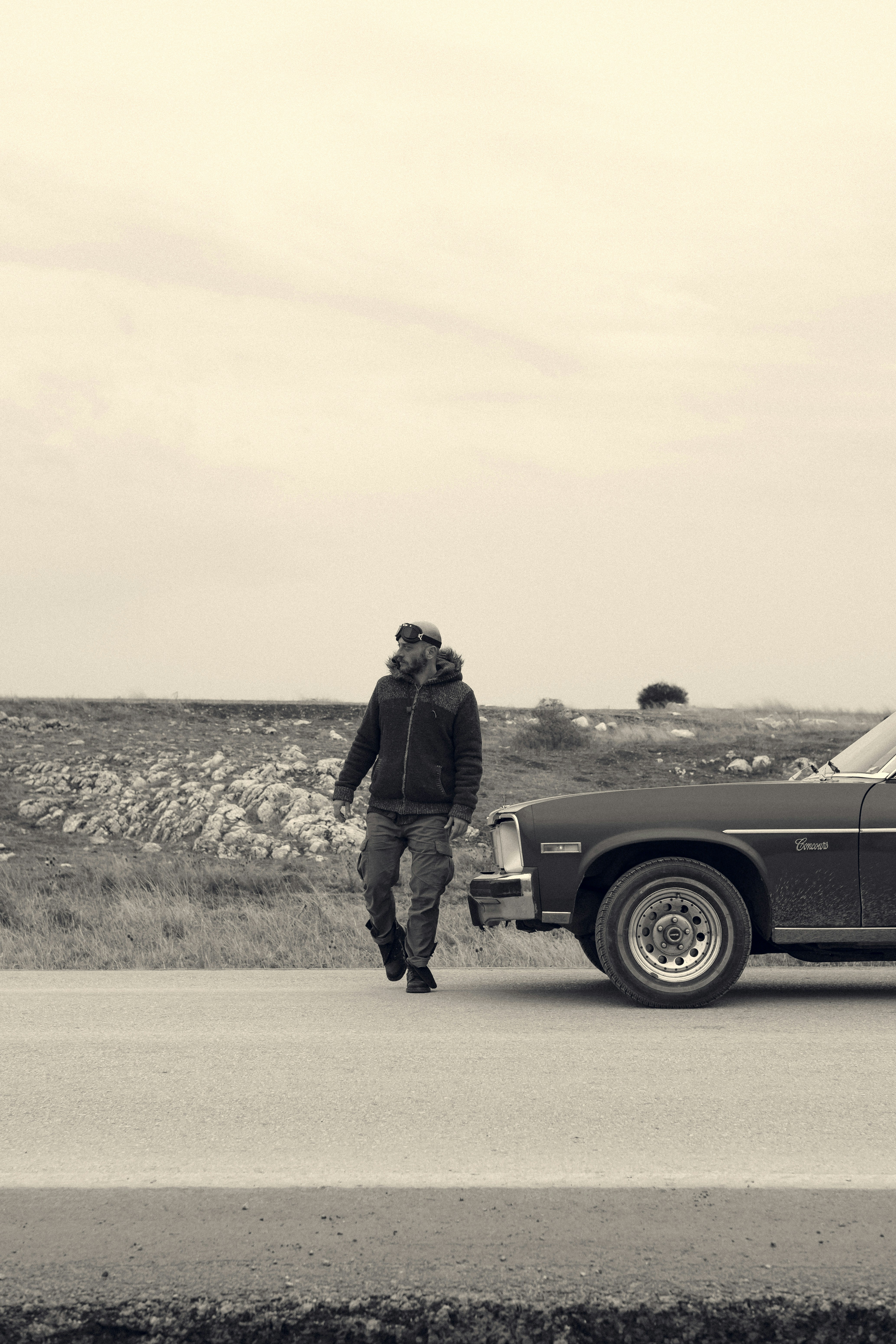 Dust on the Horizon: A solitary wanderer by a vintage pickup
