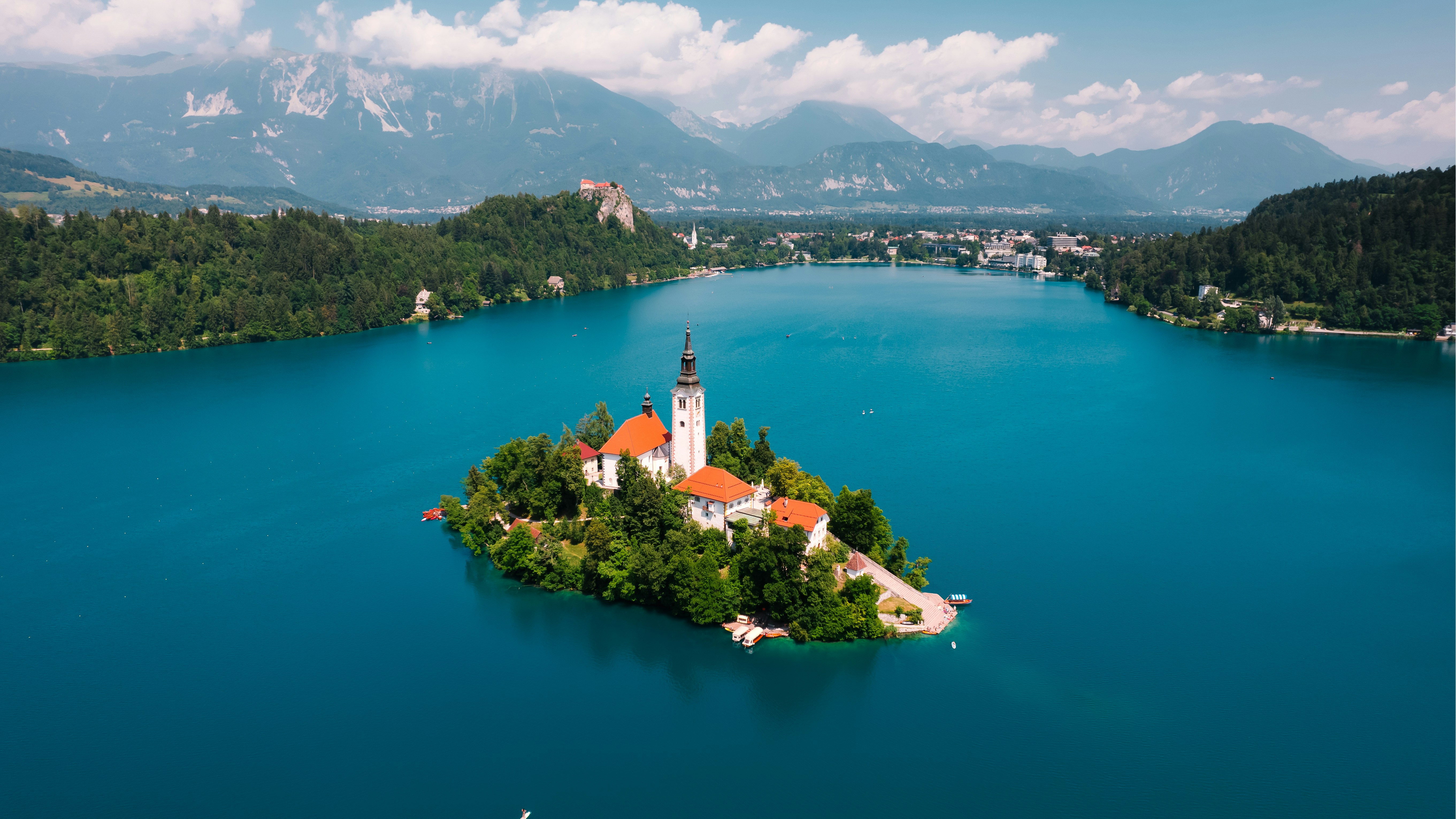 aerial view of white and brown concrete building near body of water during daytime