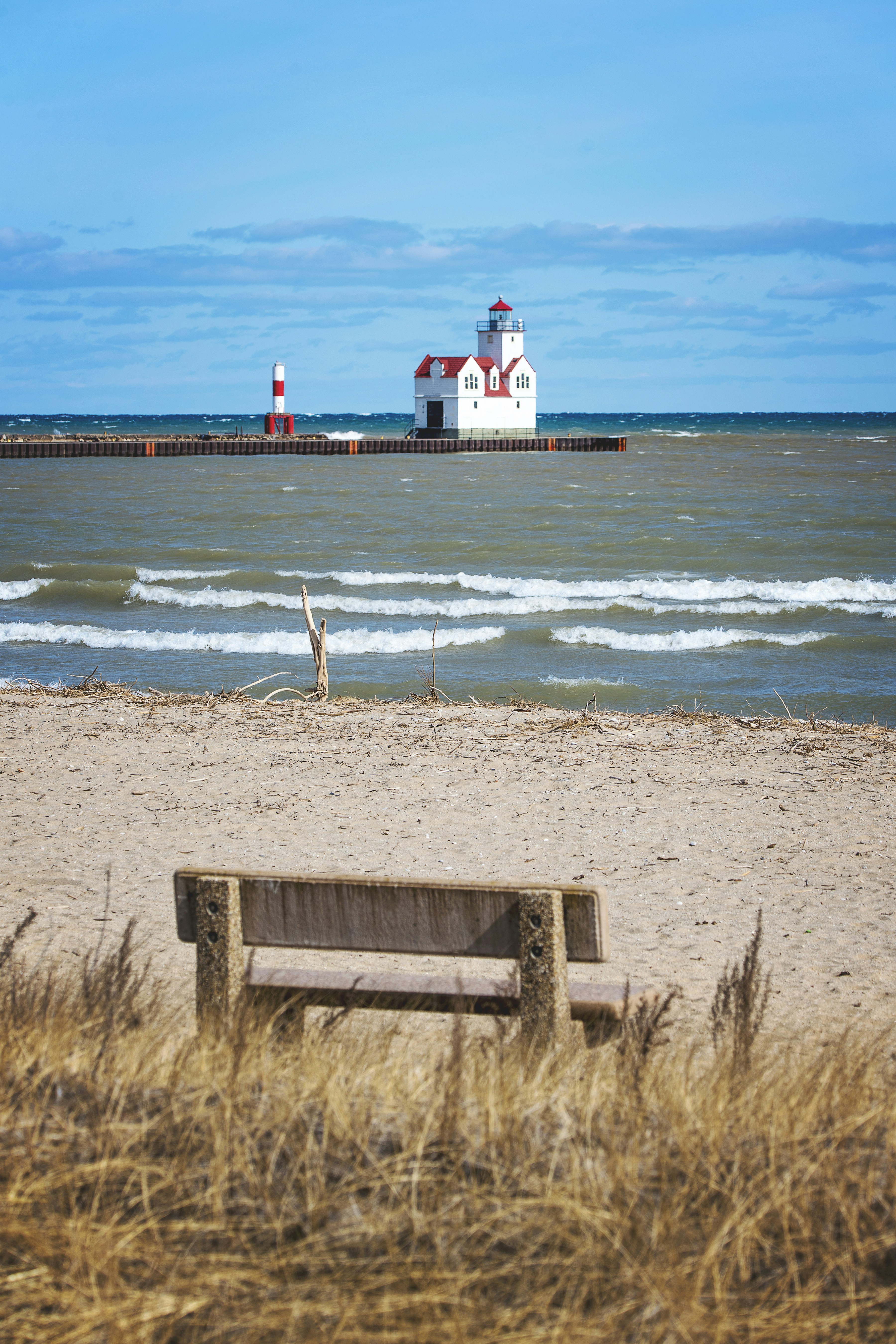 Red-Roof Lighthouse Standing Watch Over a Quiet Breakwater