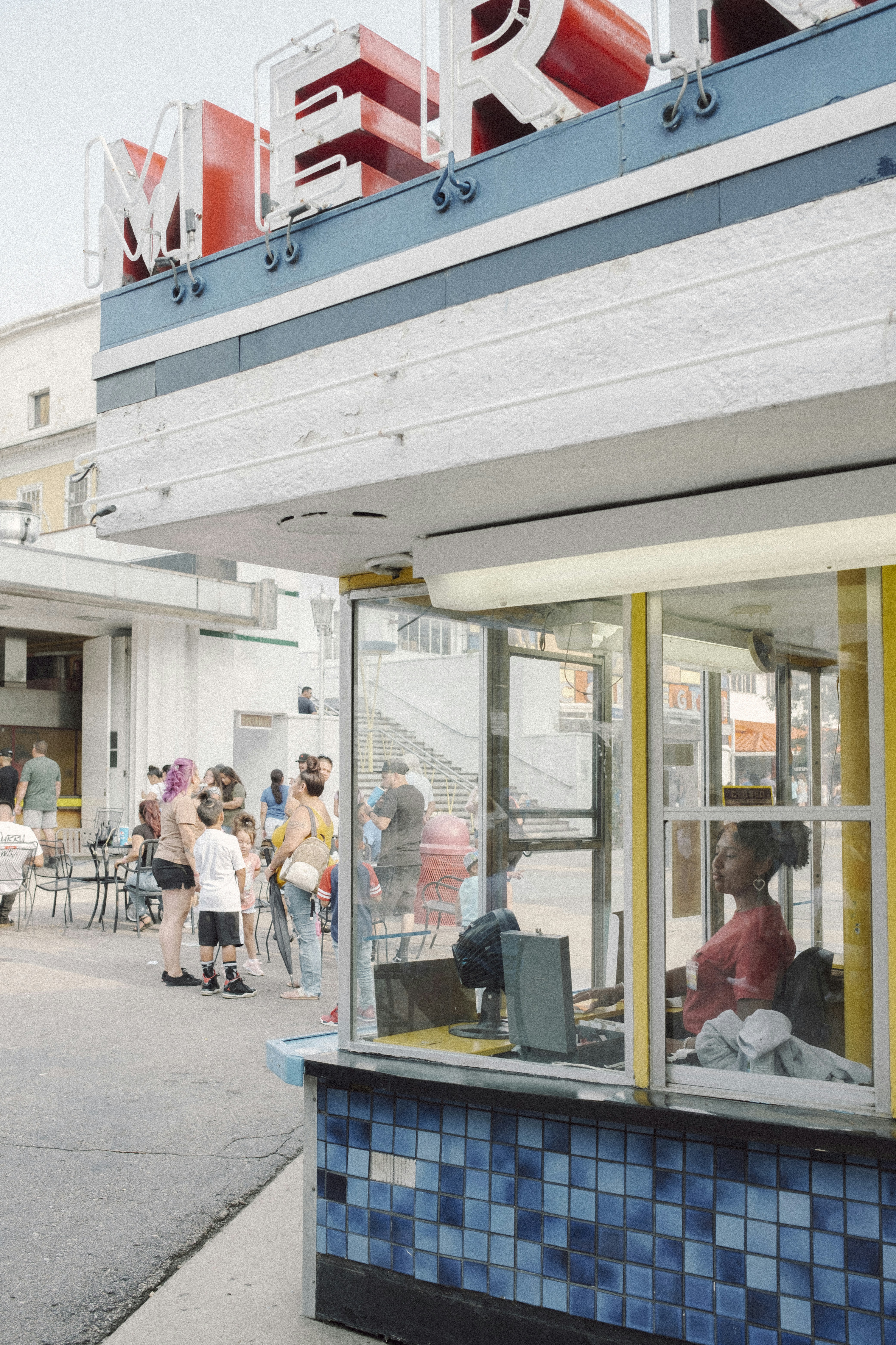 Red-Sleeve Window: A Daylight Moment at the Retro Kiosk
