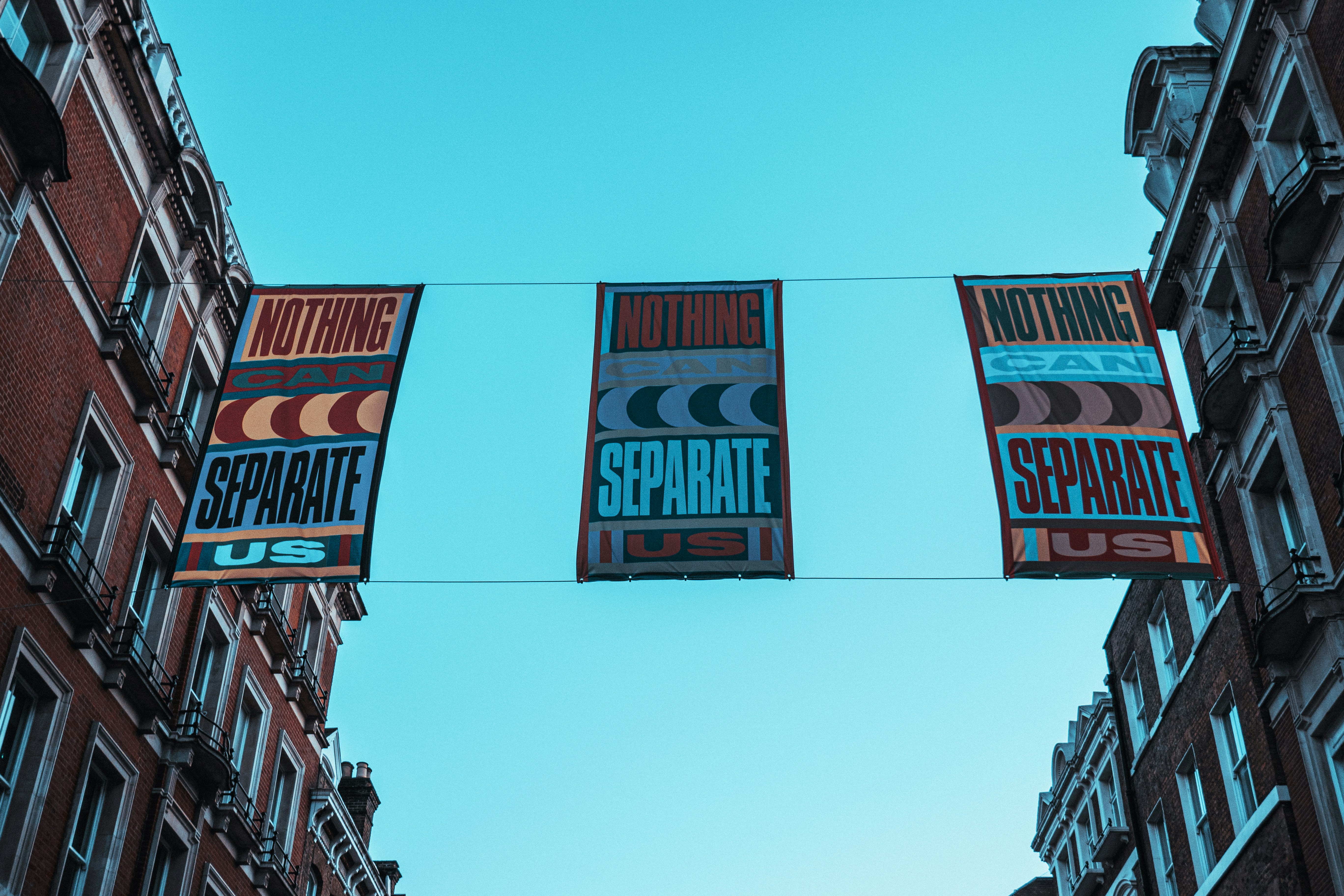 A couple of banners hanging from a wire photo – Free London Image on ...