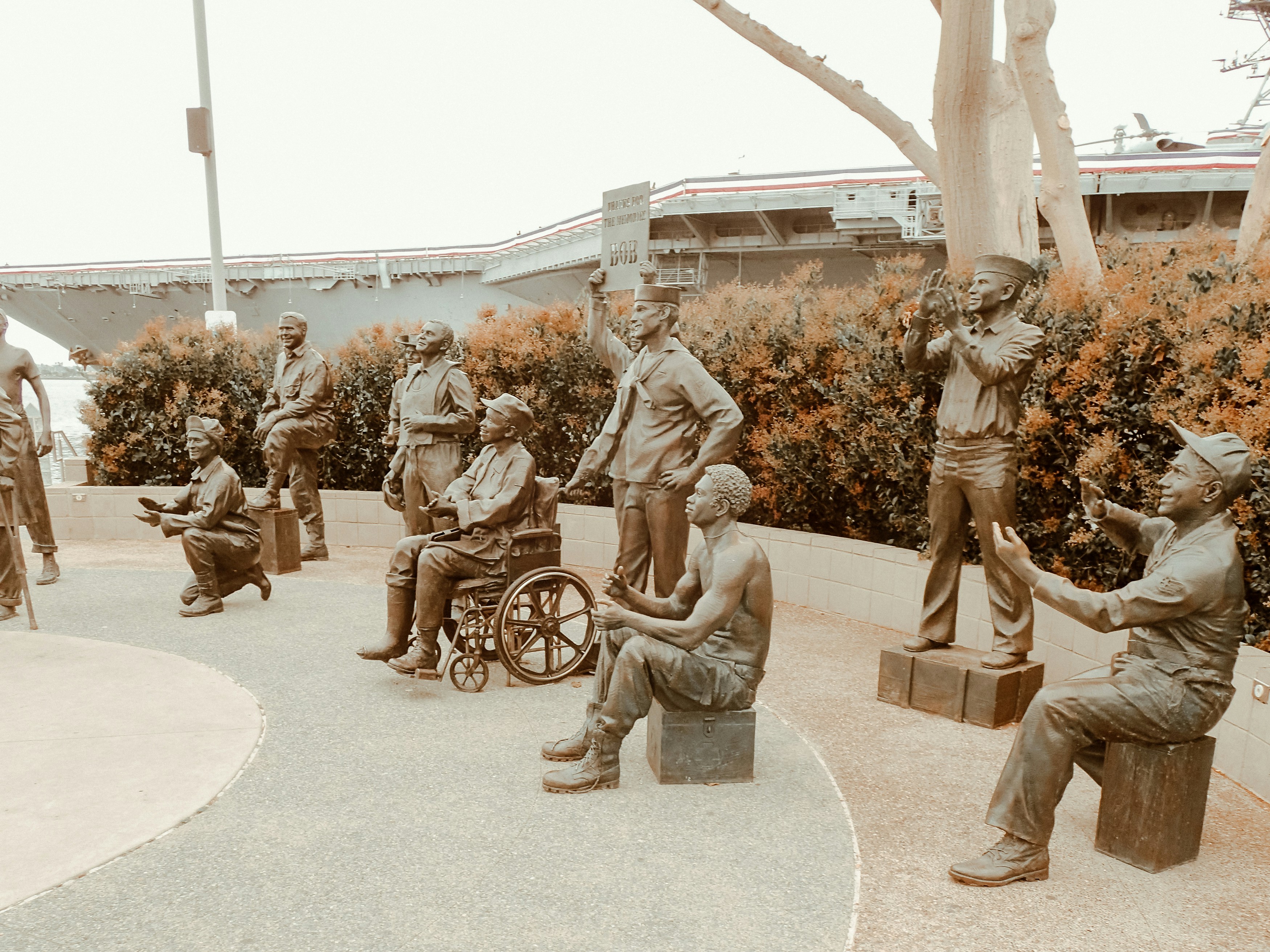 Bronze sculptures depicting workers in various poses, celebrating labor and community spirit. The scene captures a moment of reflection and camaraderie among the figures.