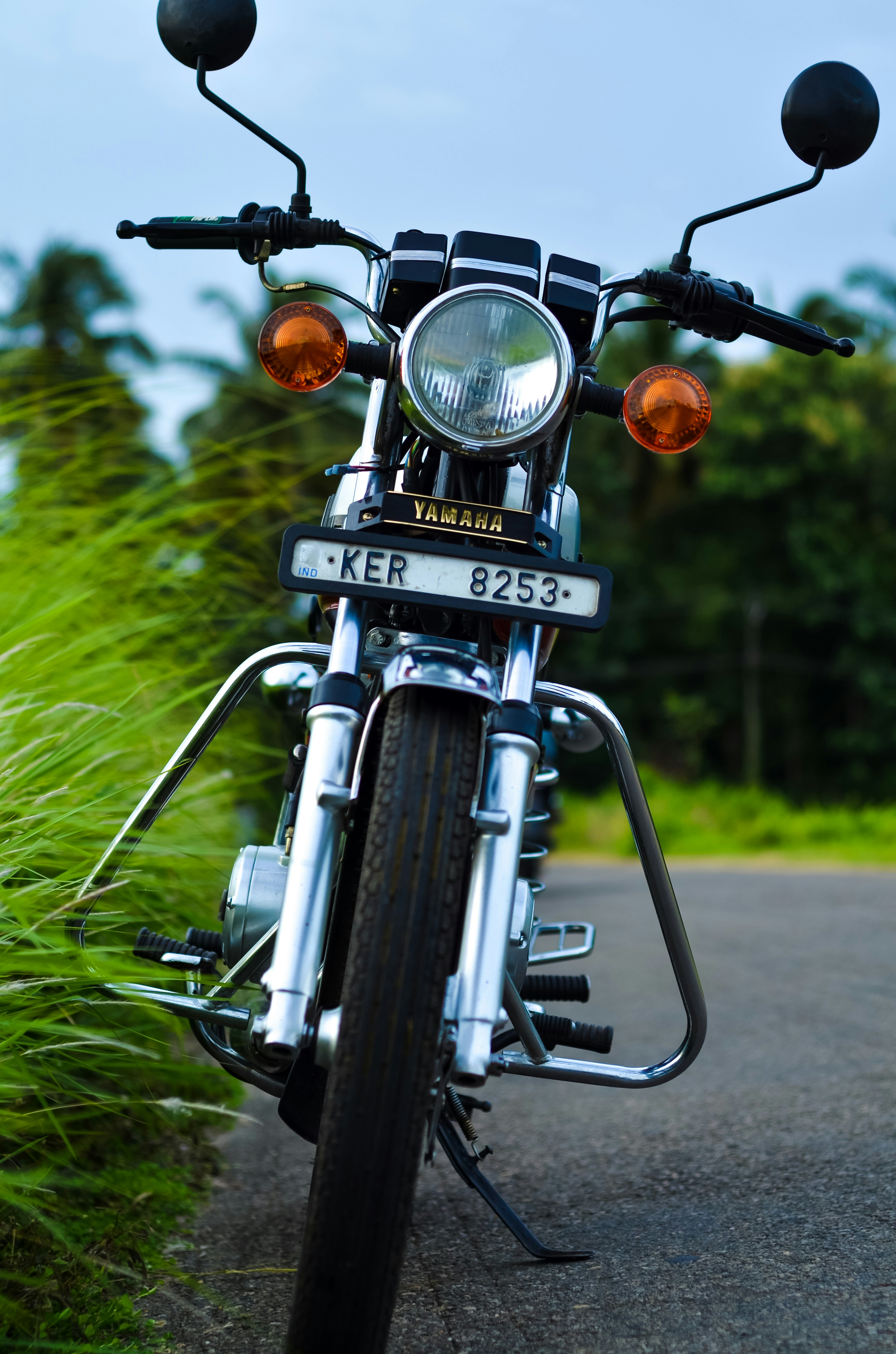 Black motorcycle parked on green grass field during daytime photo ...