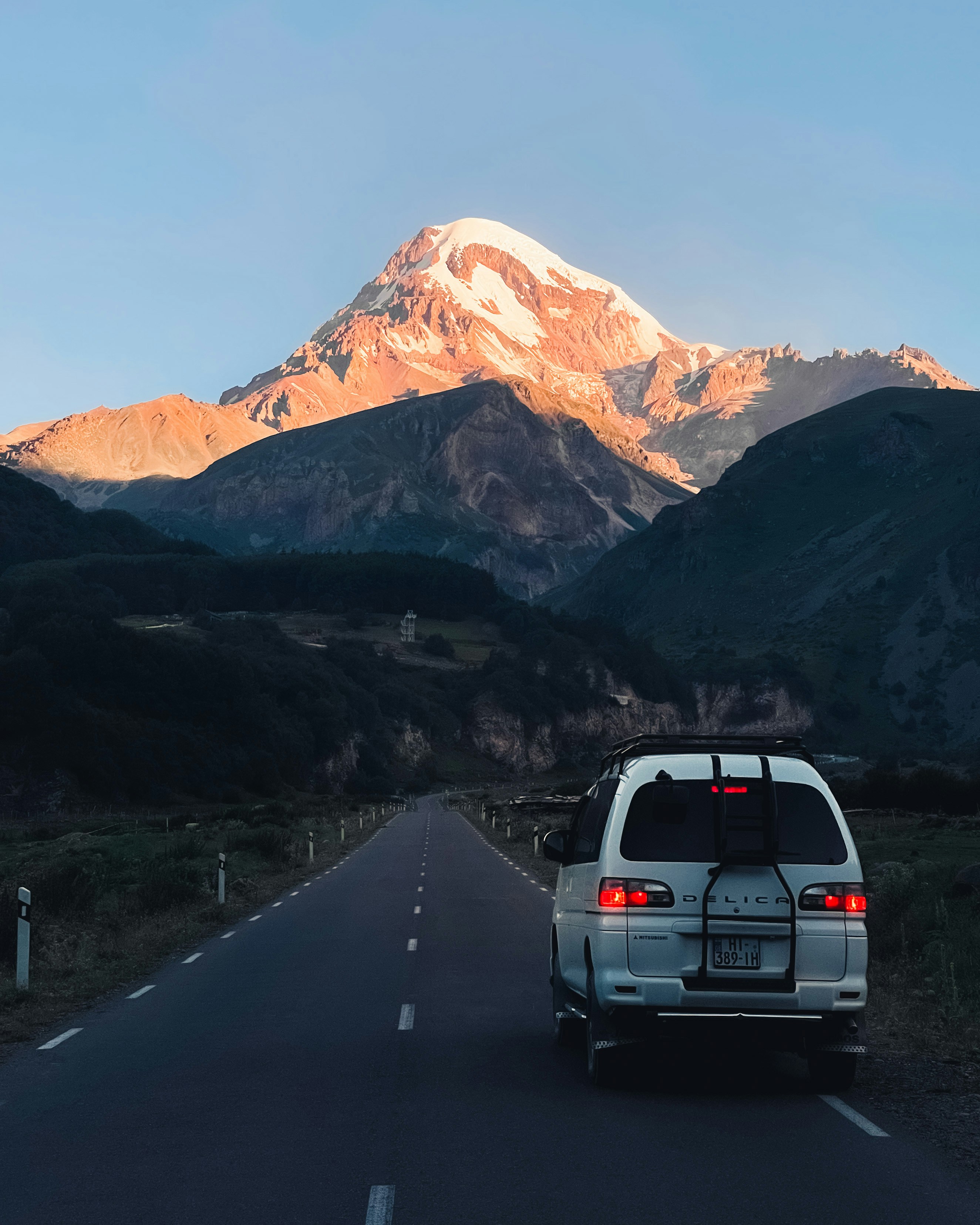 Luminous Summit Beyond a Quiet Alpine Road