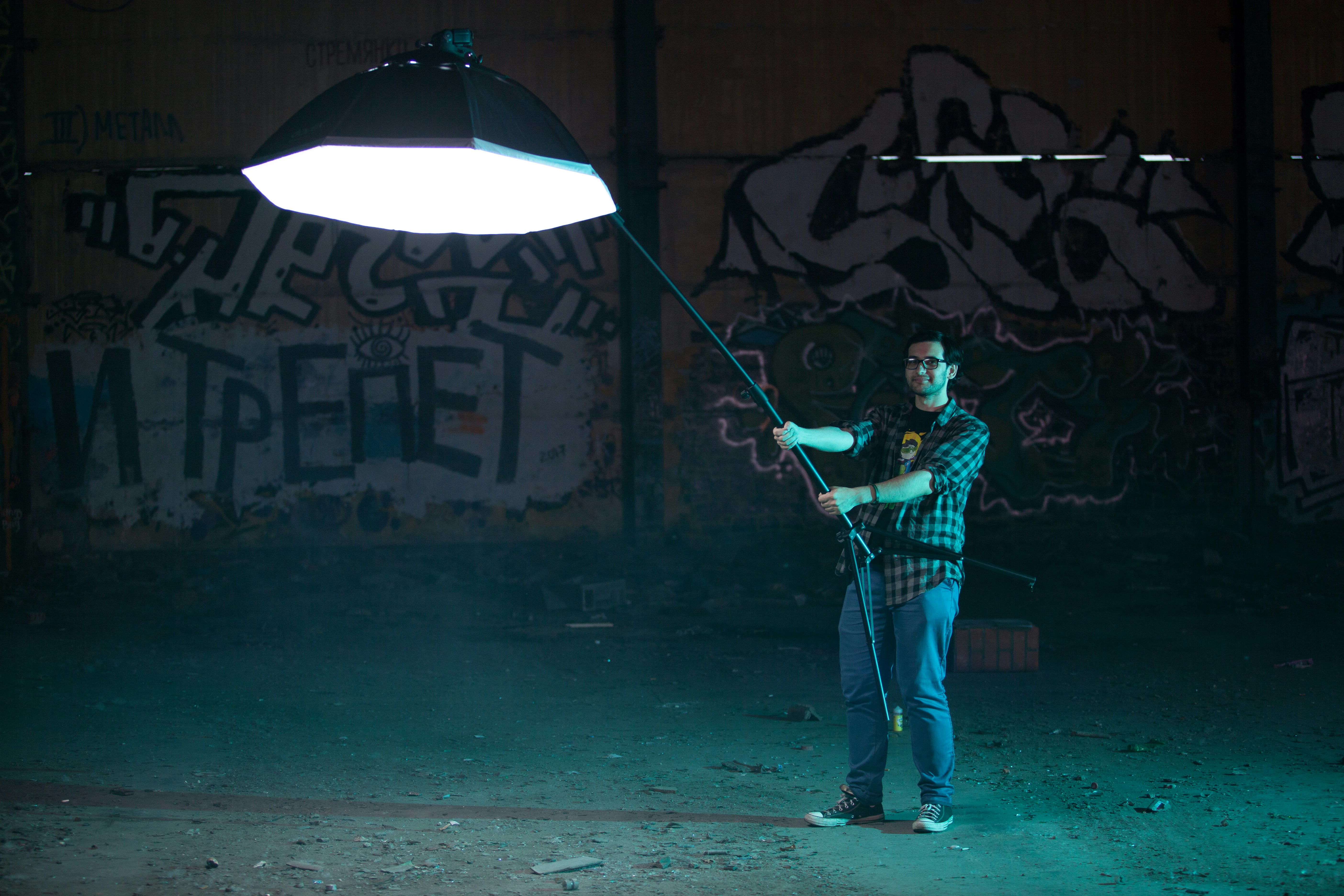 Late-Night Light Tug: A lone operator in an abandoned mural-filled space
