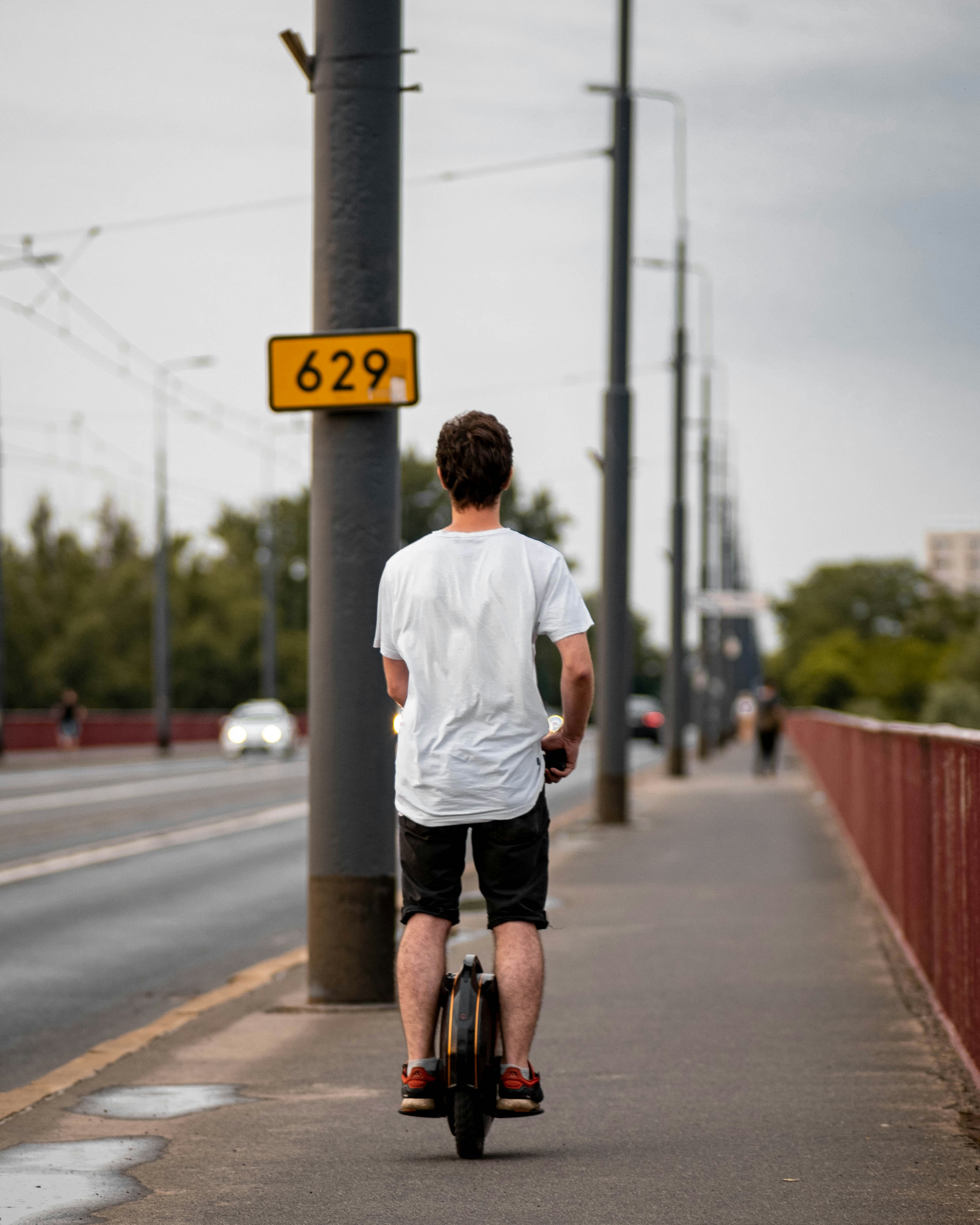 Midtown Courier: A lone rider on a city bridge