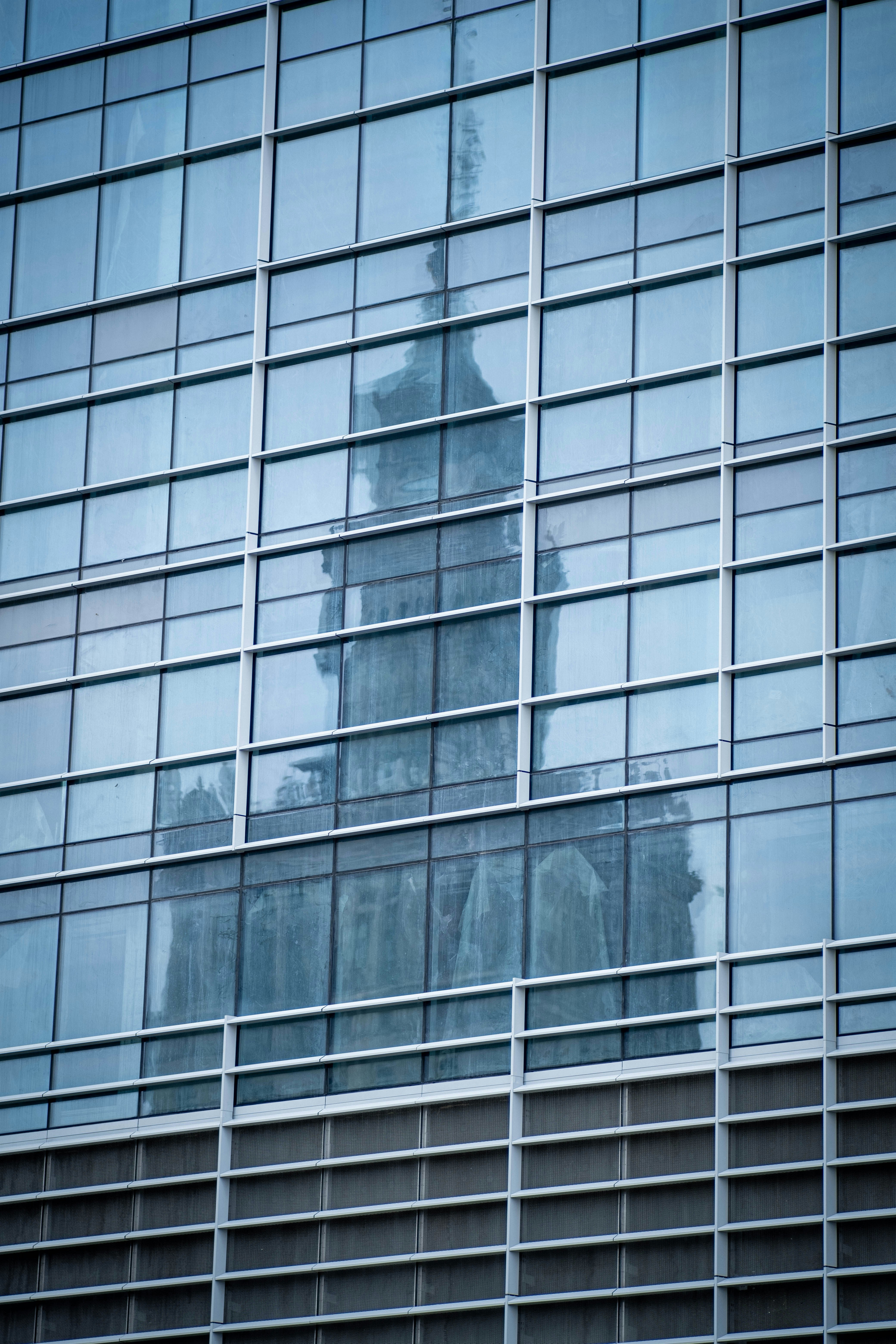 Grid Reflections: Statue in Blue Glass