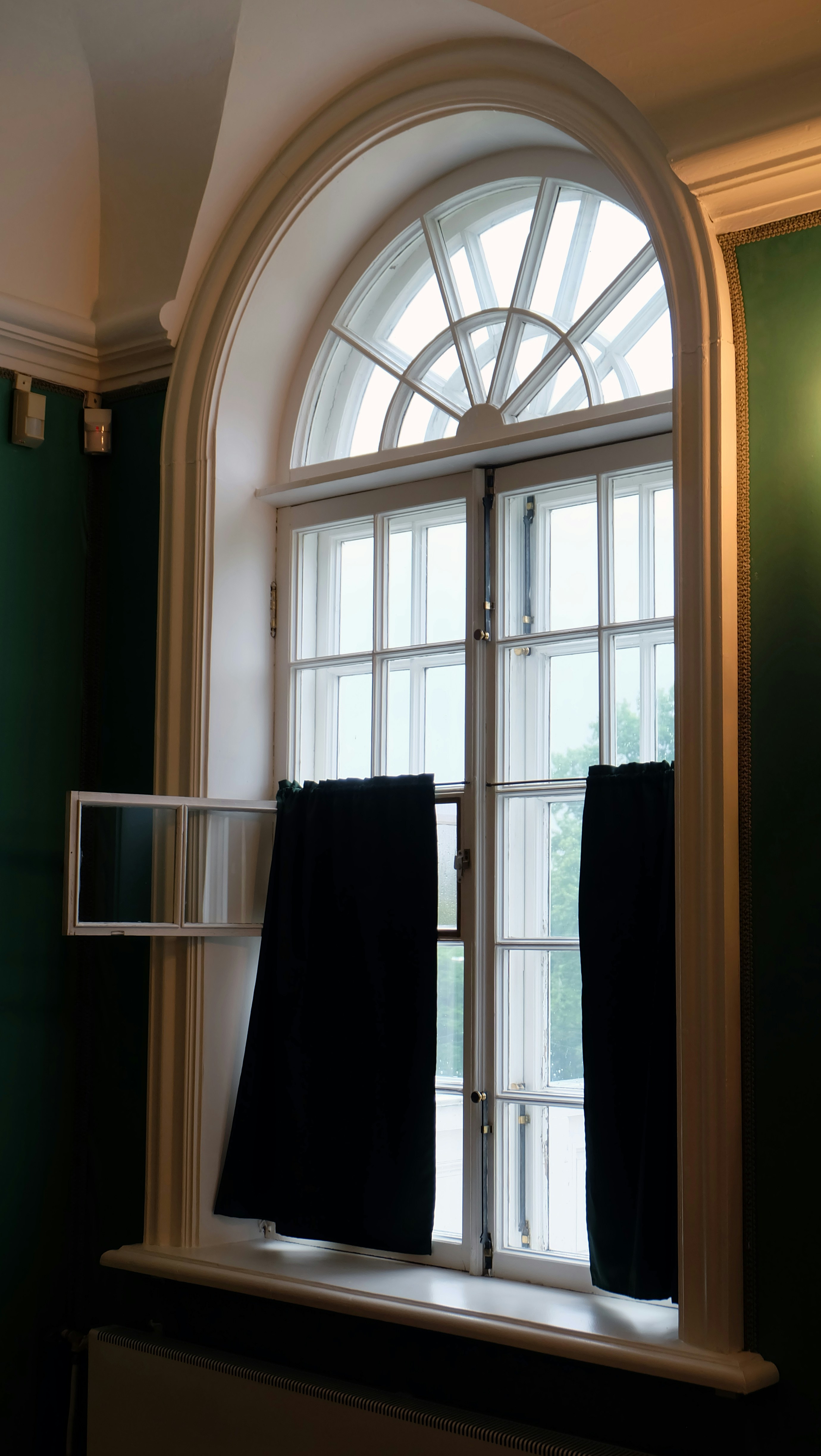 Arched Window Nook with Dark Drapes