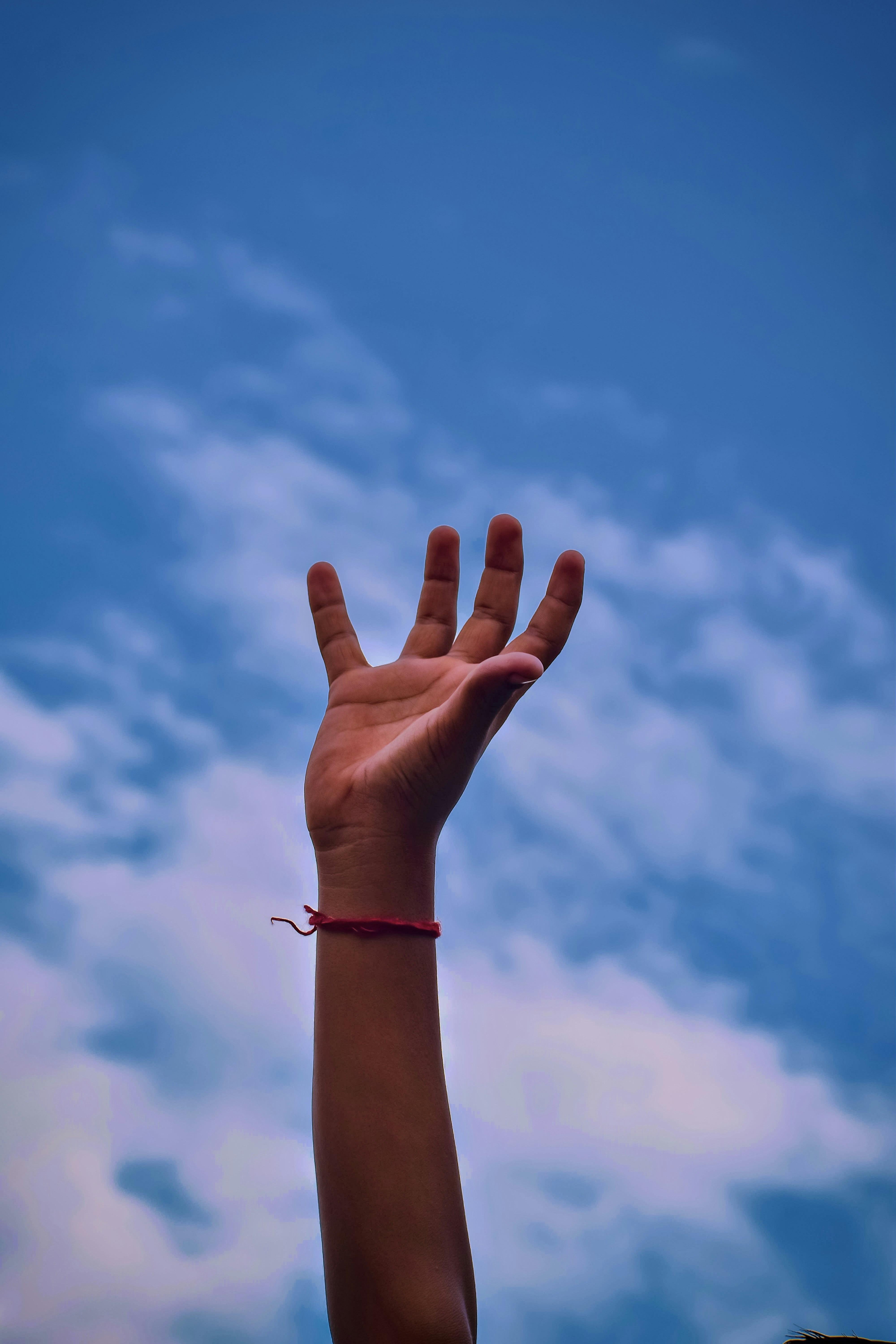 Person raising right hand under blue sky during daytime photo – Free ...