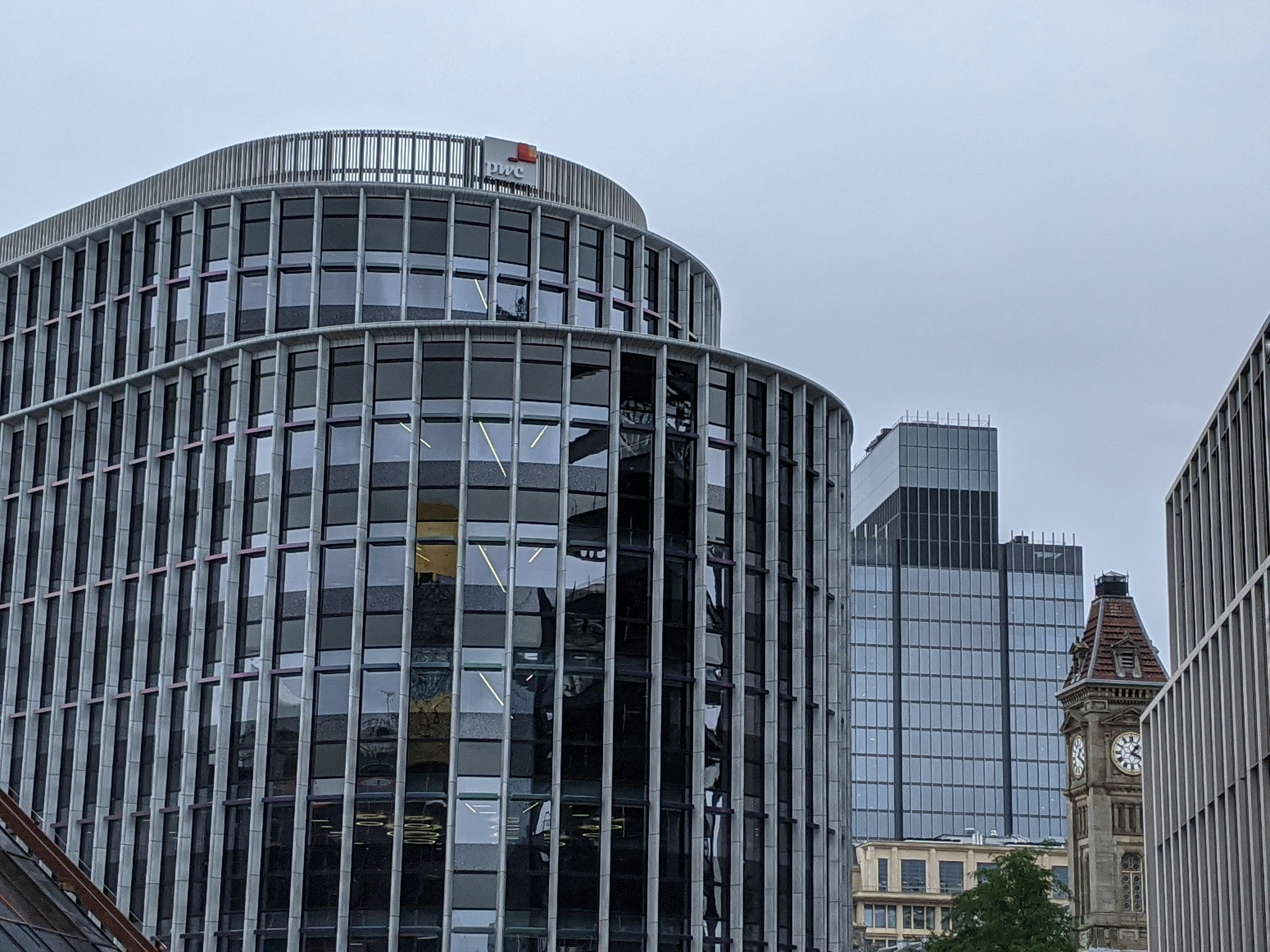 Paradise Circus development with Birmingham Museum clock tower and 103 Colmore Row in the background. | white and black concrete building during daytime