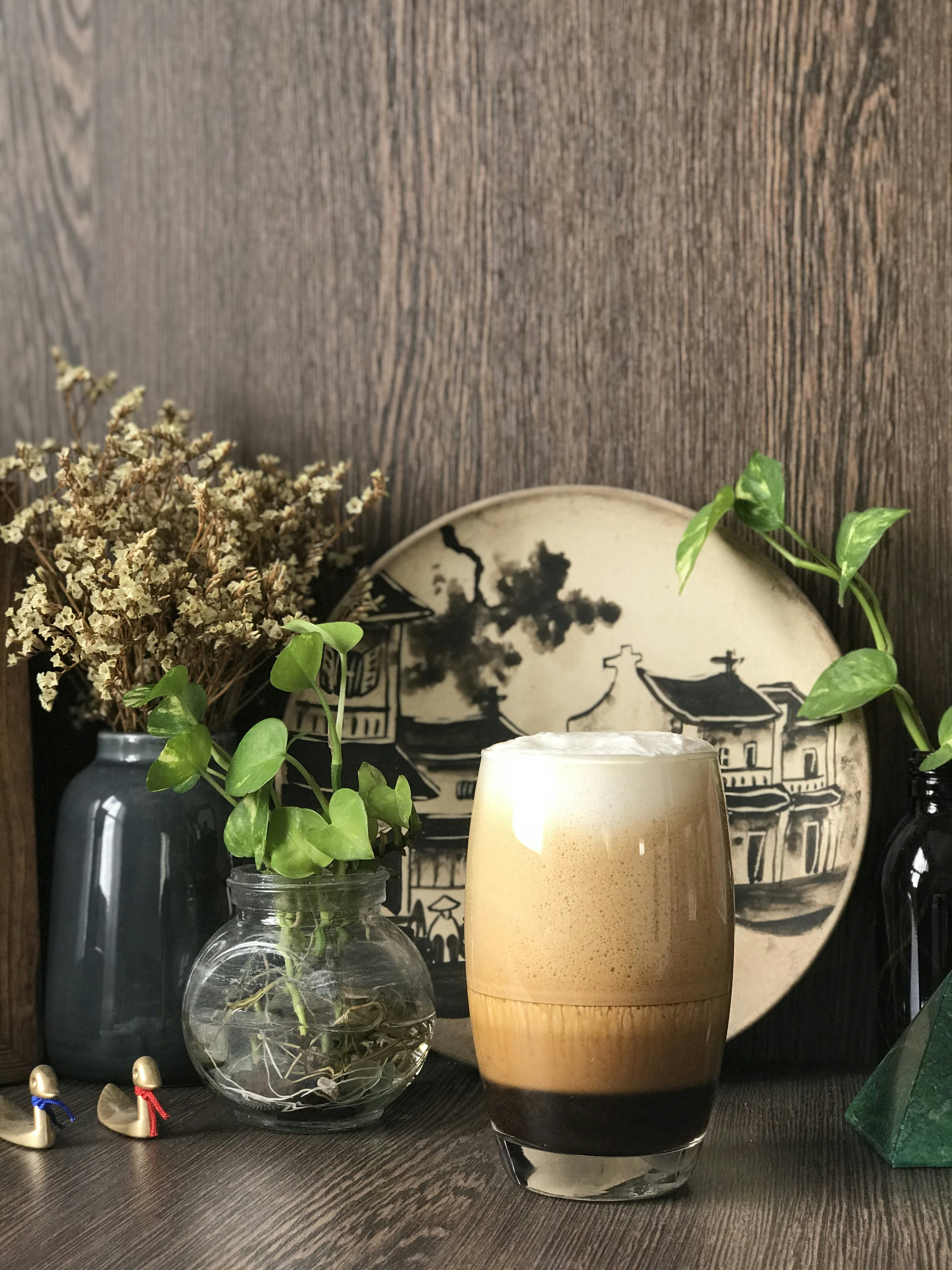 clear glass mug with brown liquid inside