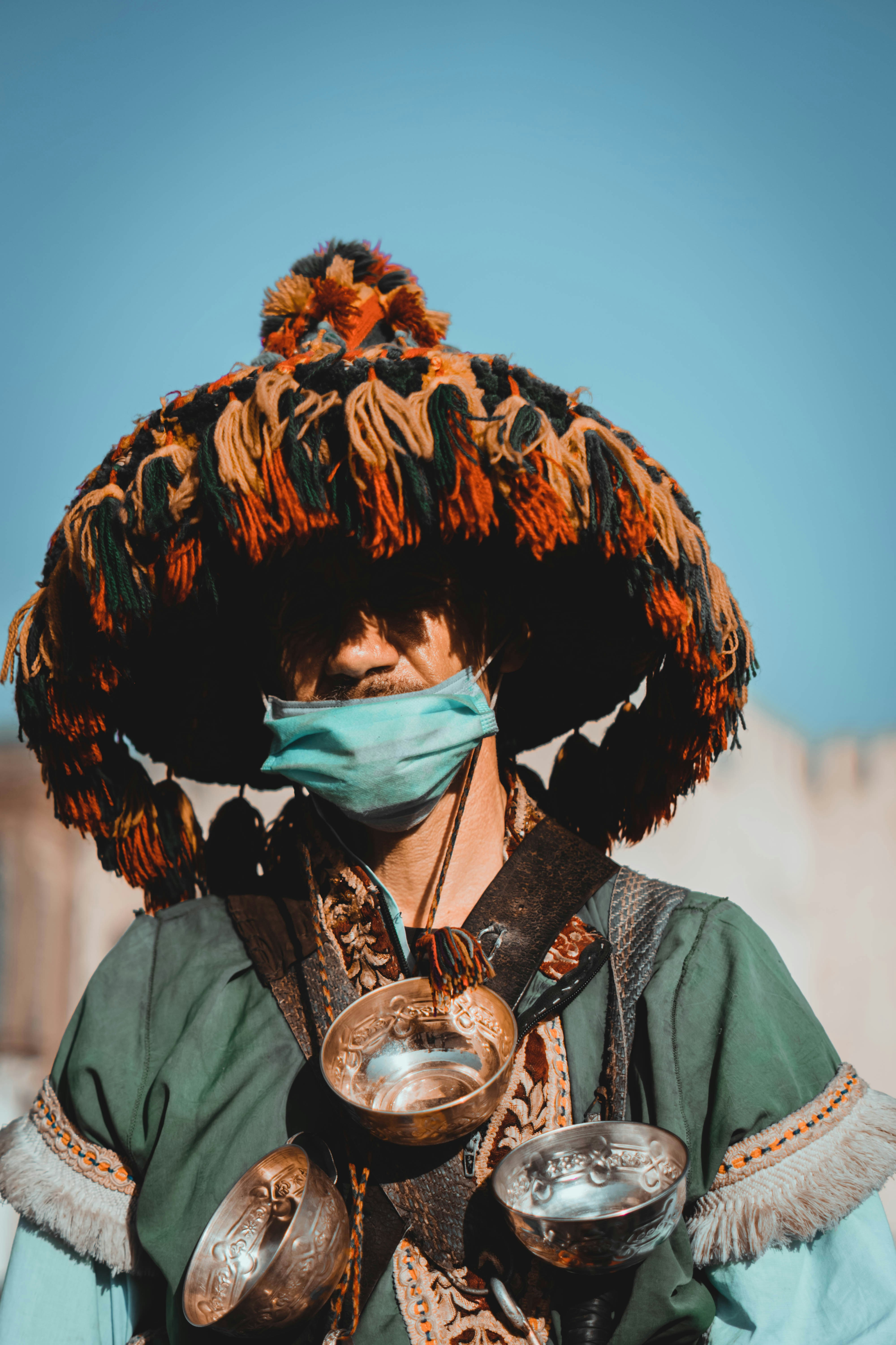Masked Festival Attire: A Turbaned Figure in Turquoise