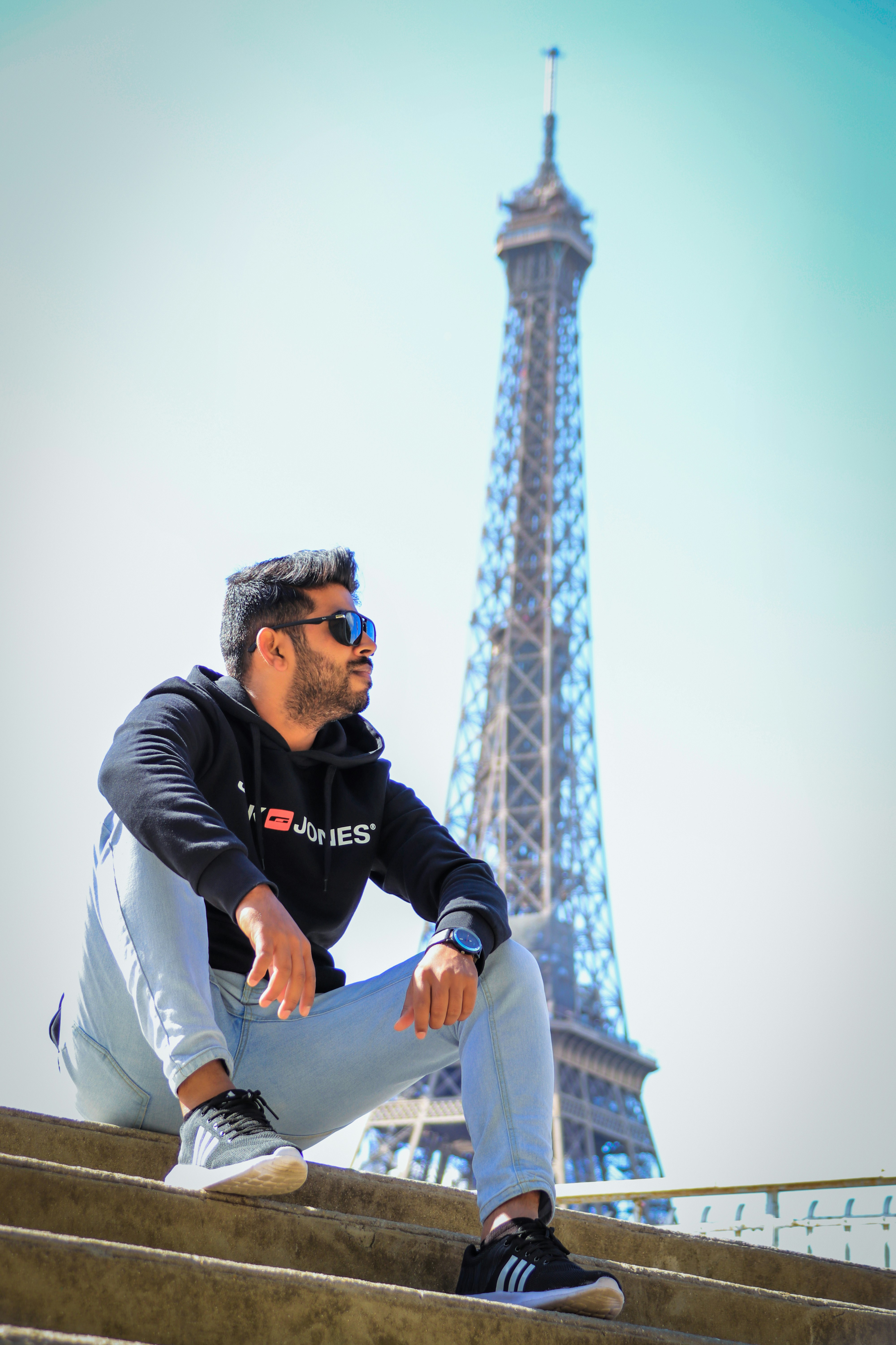 Urban Summit: A contemplative silhouette before the Eiffel Frame