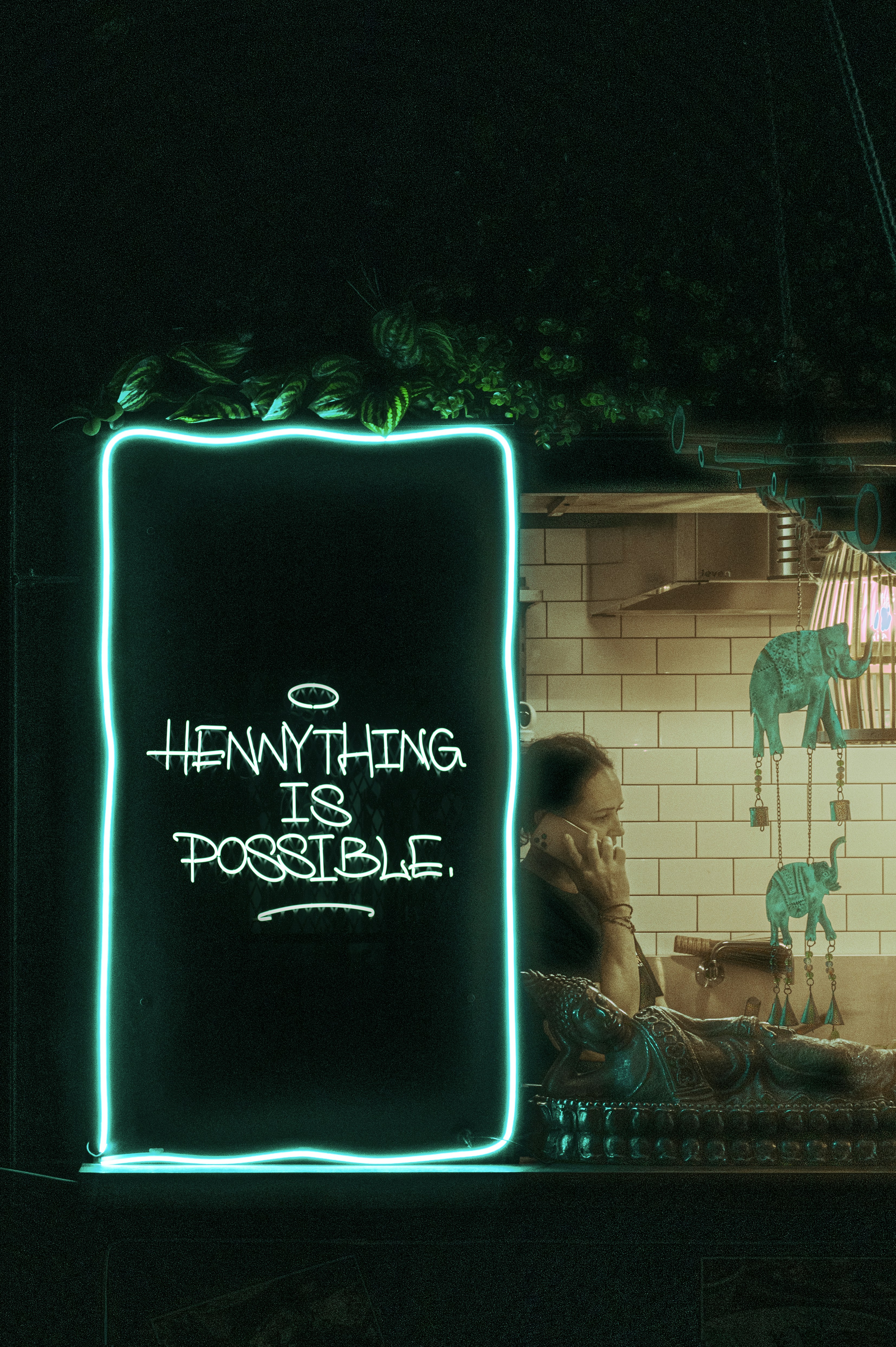 Neon Edge of Possibility: The HENNYTHING Sign Illuminates a Quiet Café