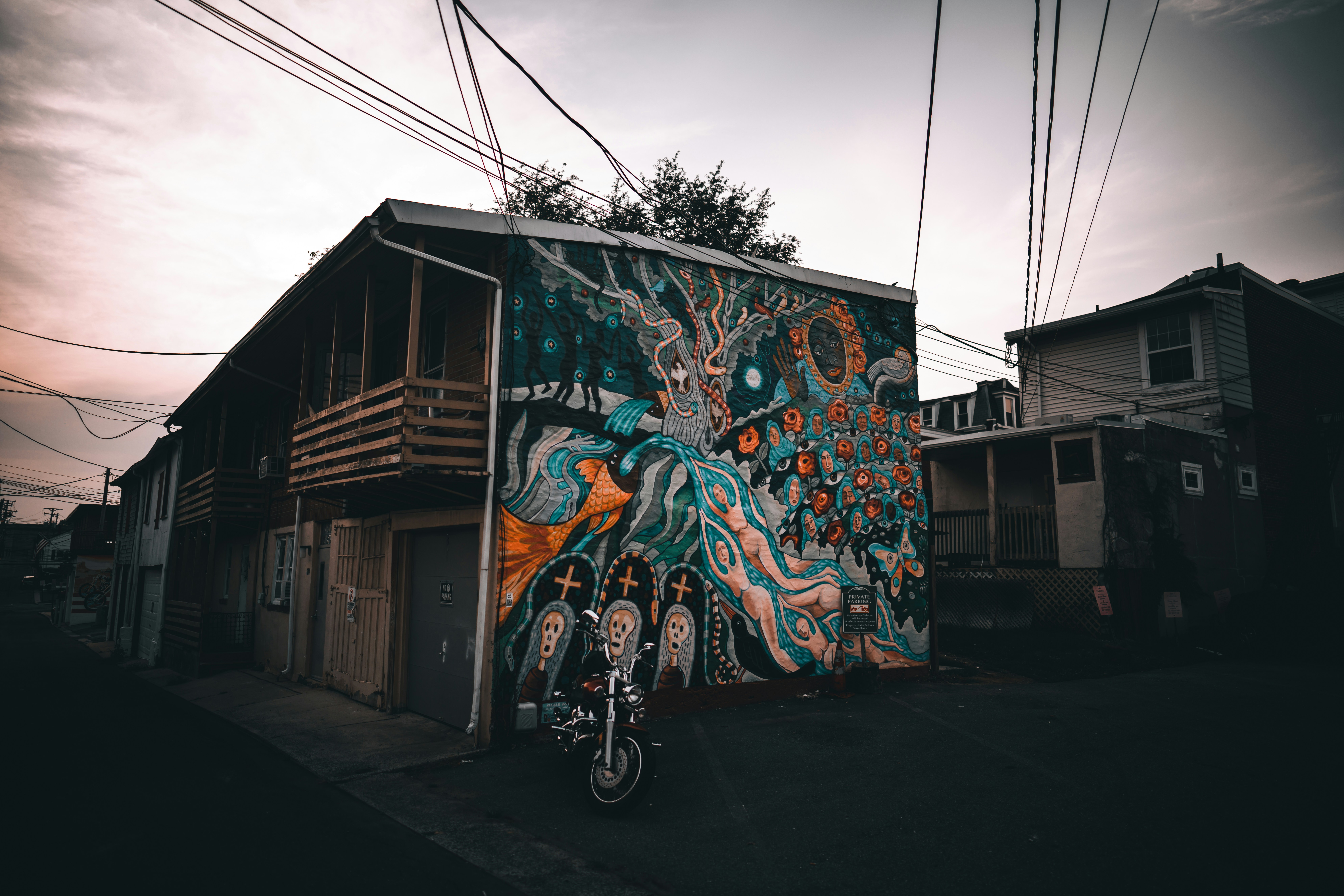 Chrome and Colors: A Motorcycle Before a Vivid Mural at Dusk