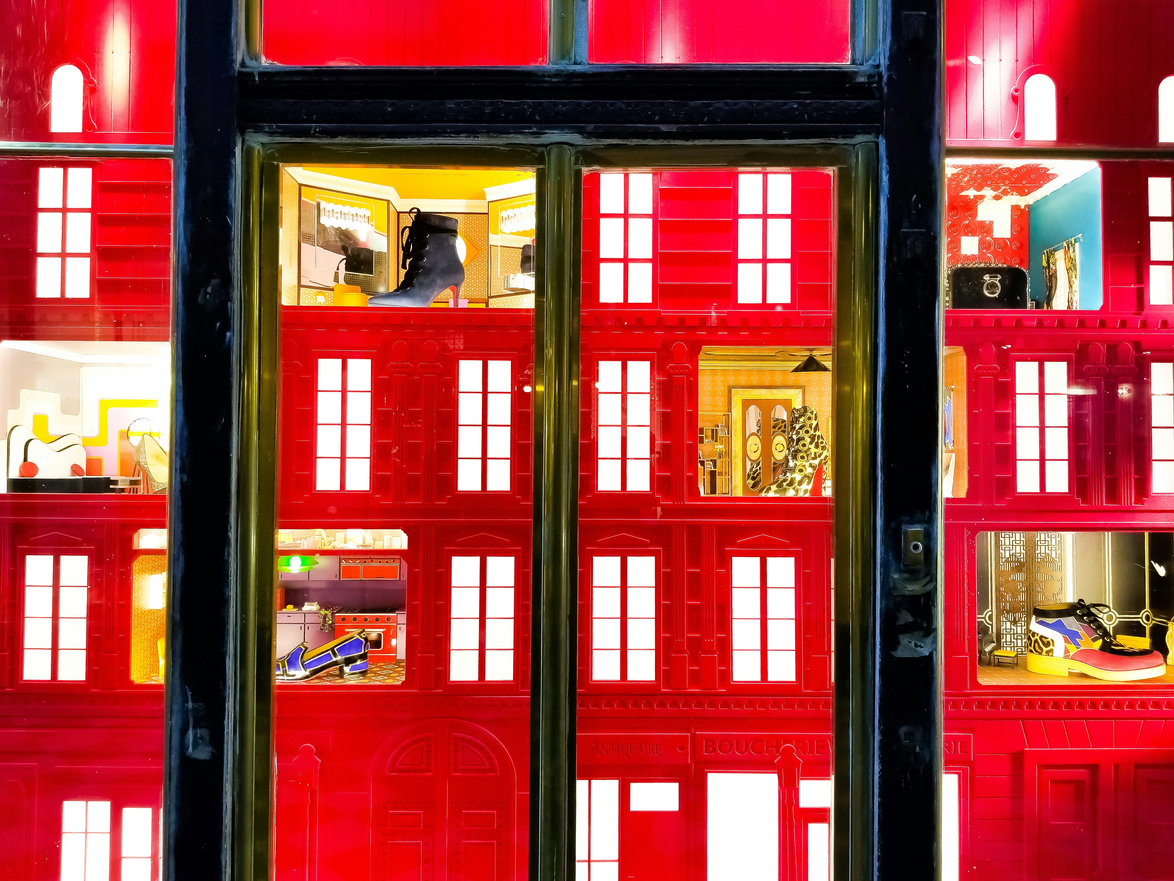 Crimson Dollhouse City: A Windowed Nightscape Framed in Glass