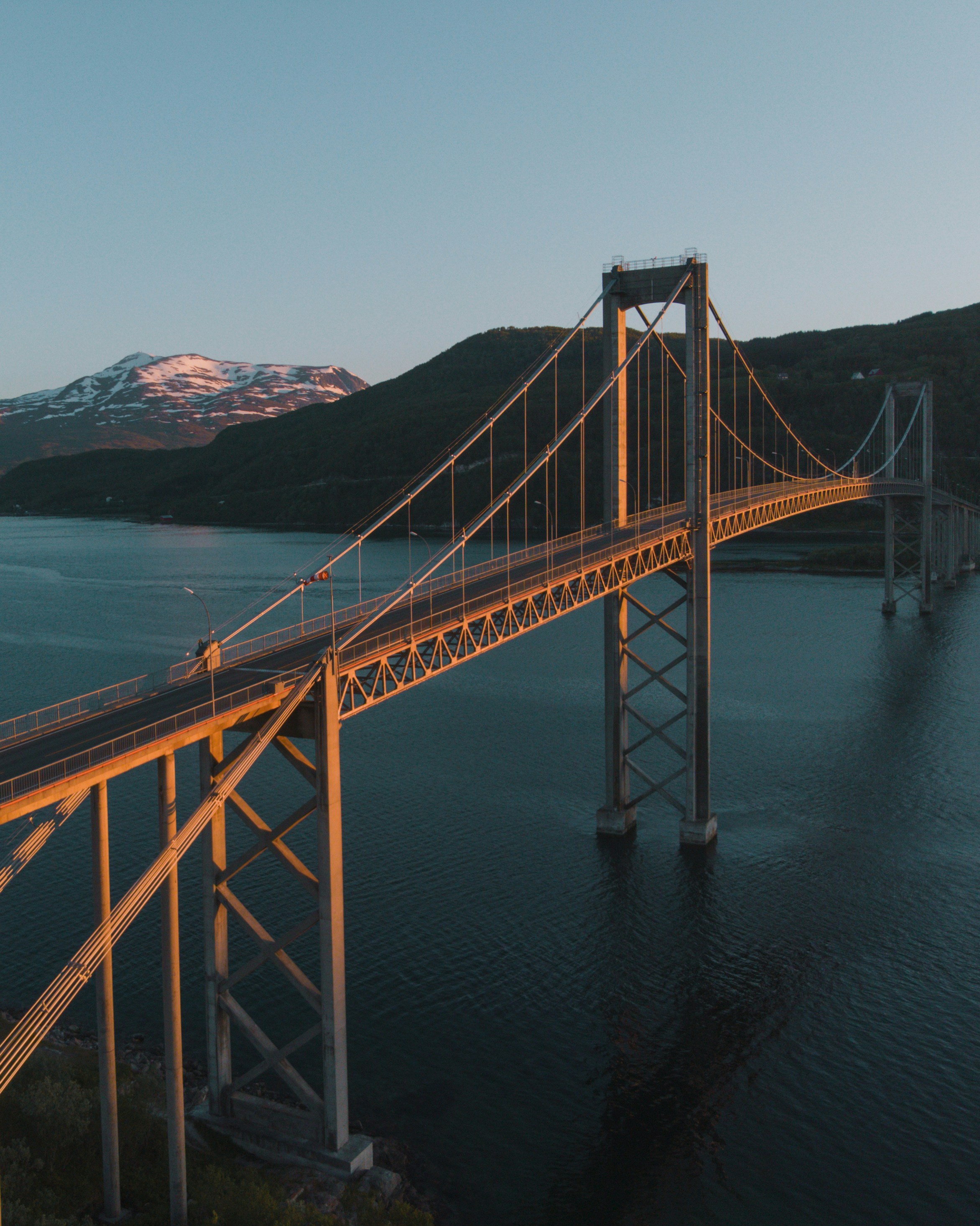 Dusk Span: A Steel Bridge Looms Over a Quiet Fjord