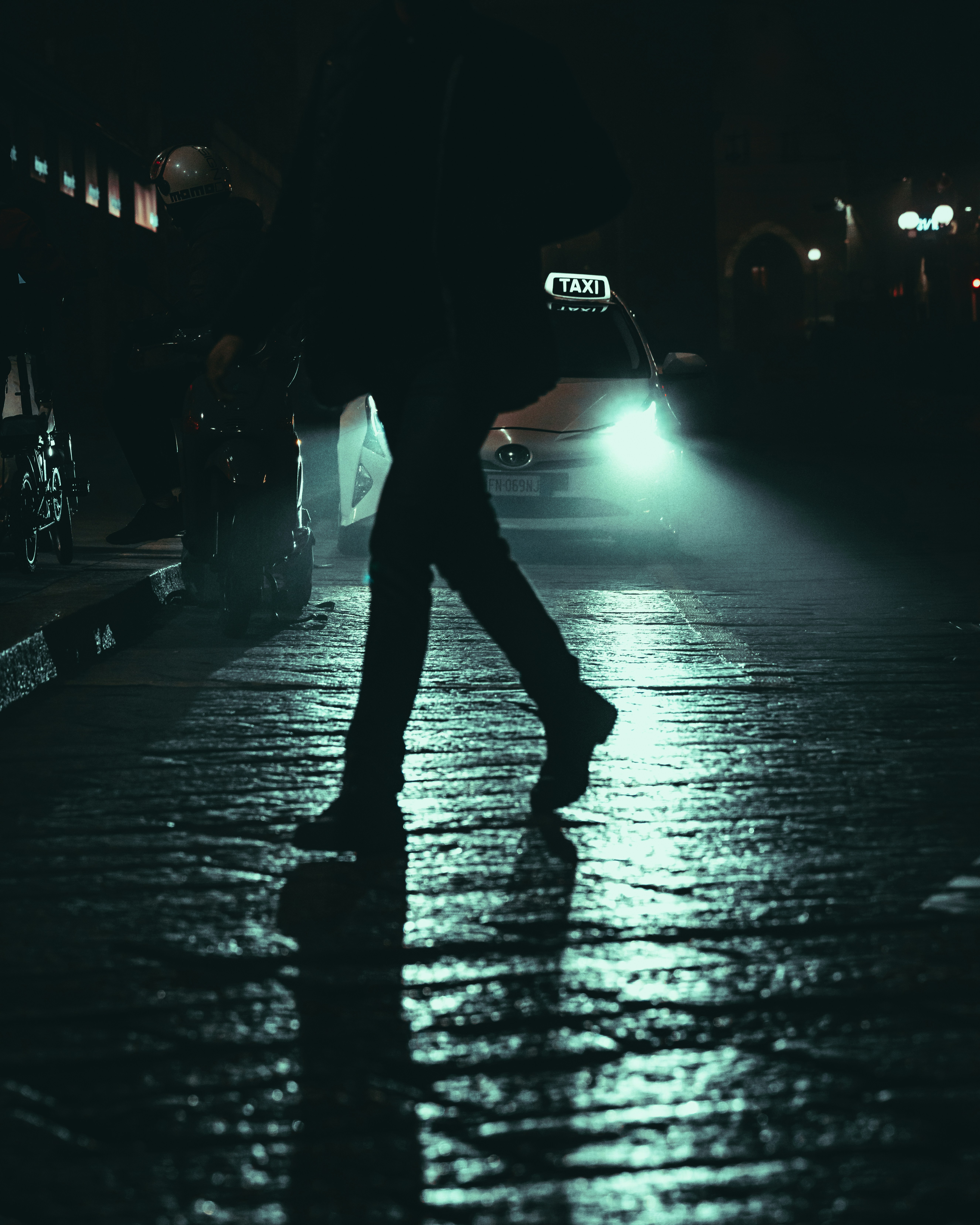 Man in black jacket walking on street during night time photo – Free ...