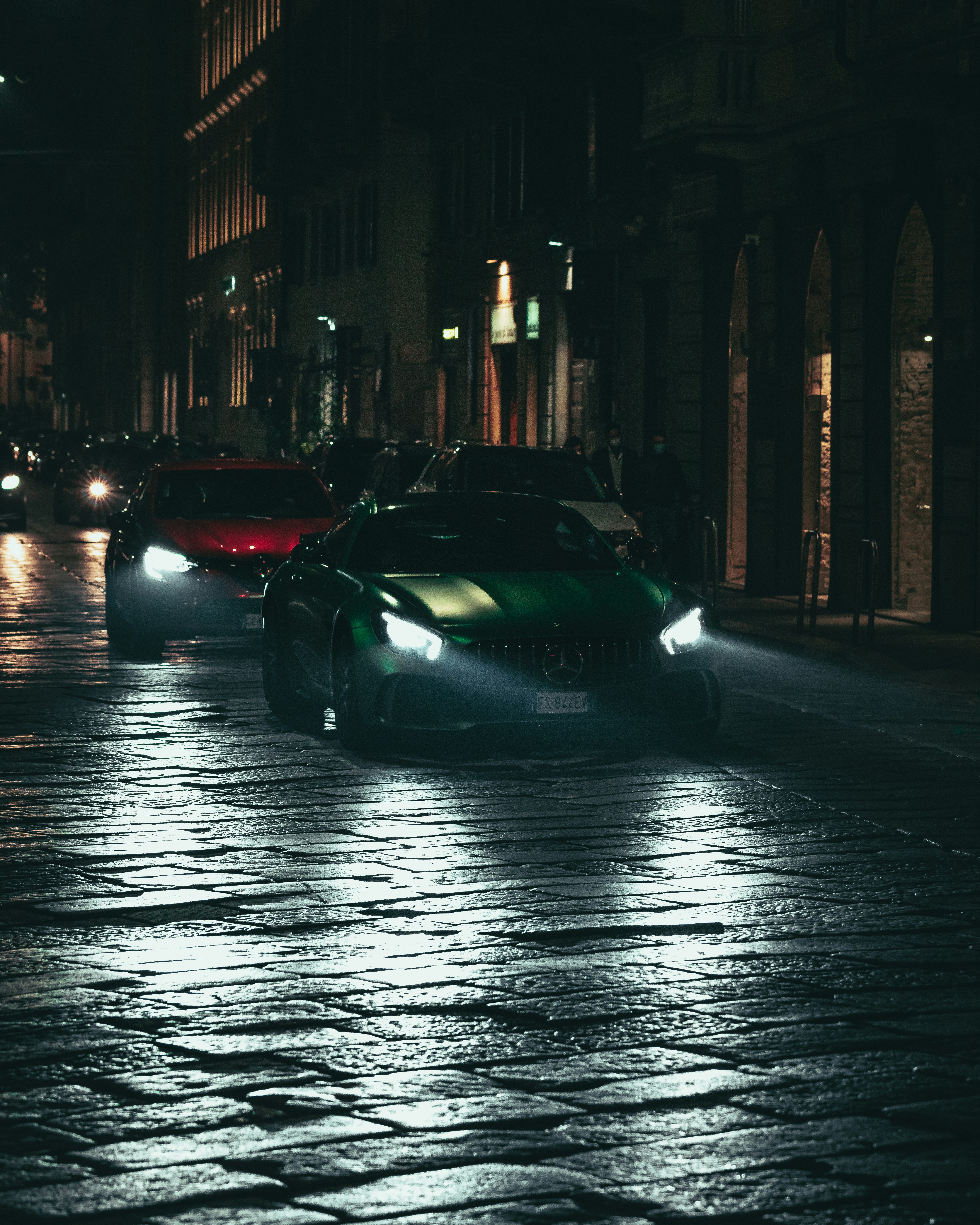 Midnight Green Coupe Dominates a Rain-Slick City Street