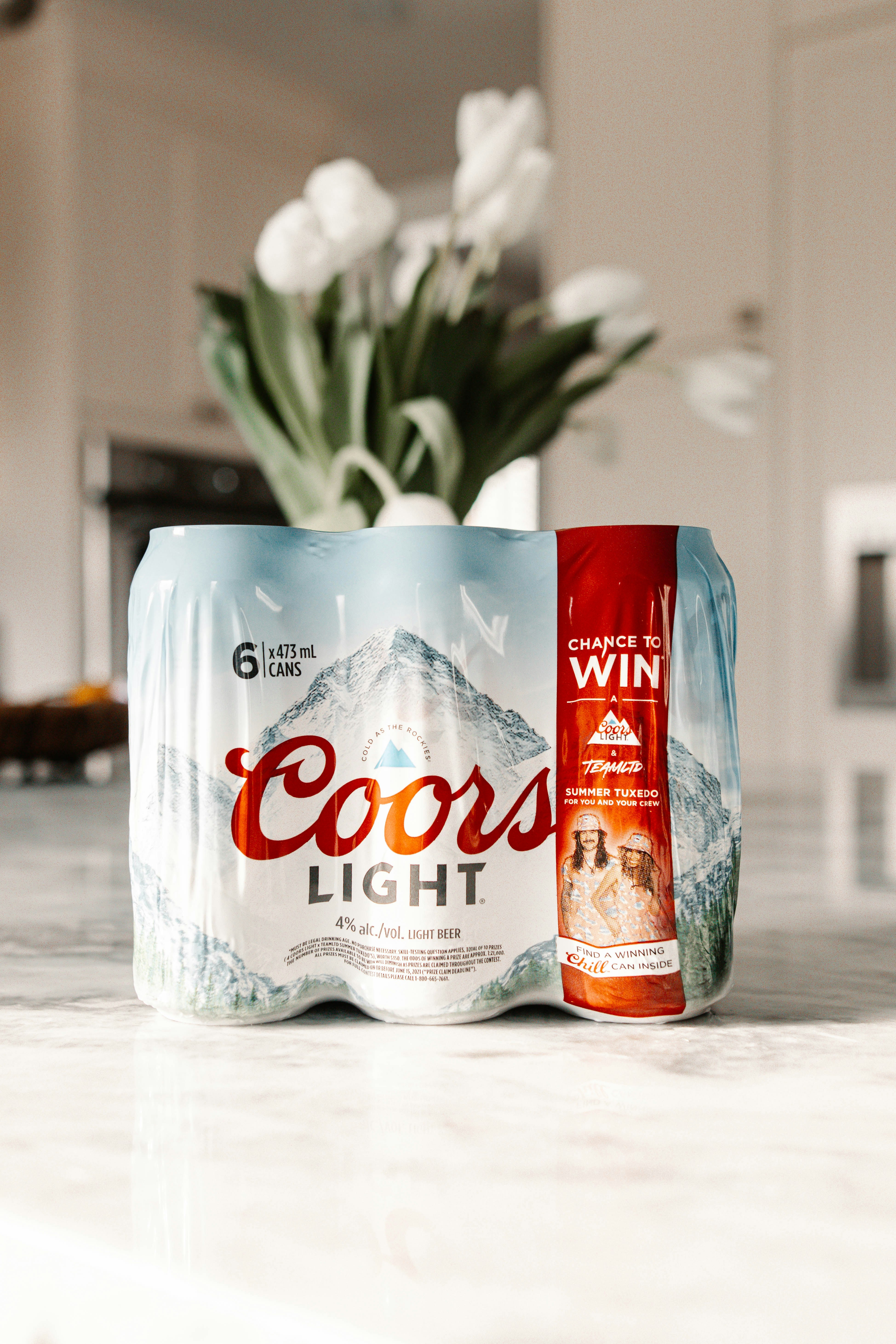 Coors Light Pack on a Marble Kitchen Island with White Tulips