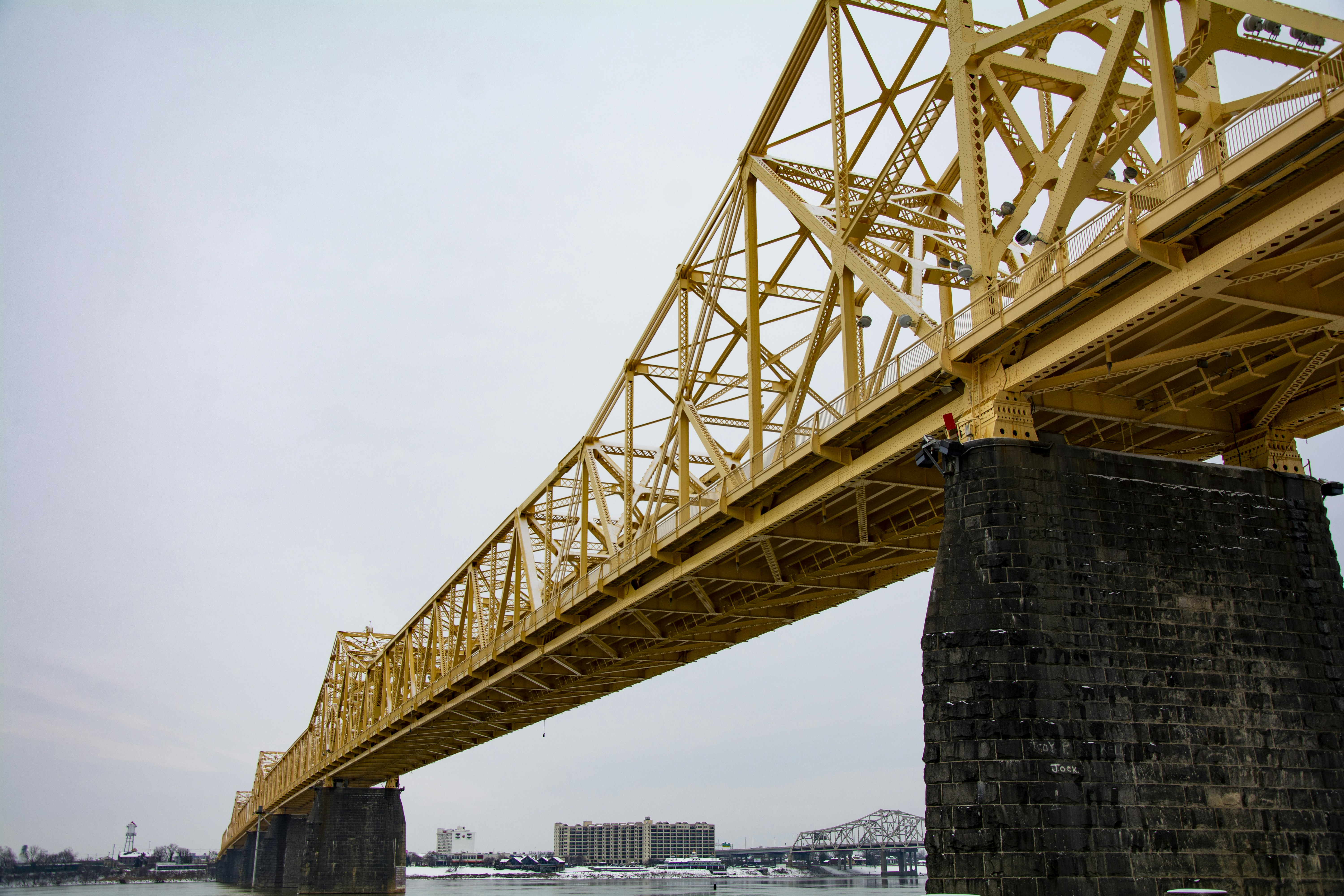 brown metal bridge over the city during daytime