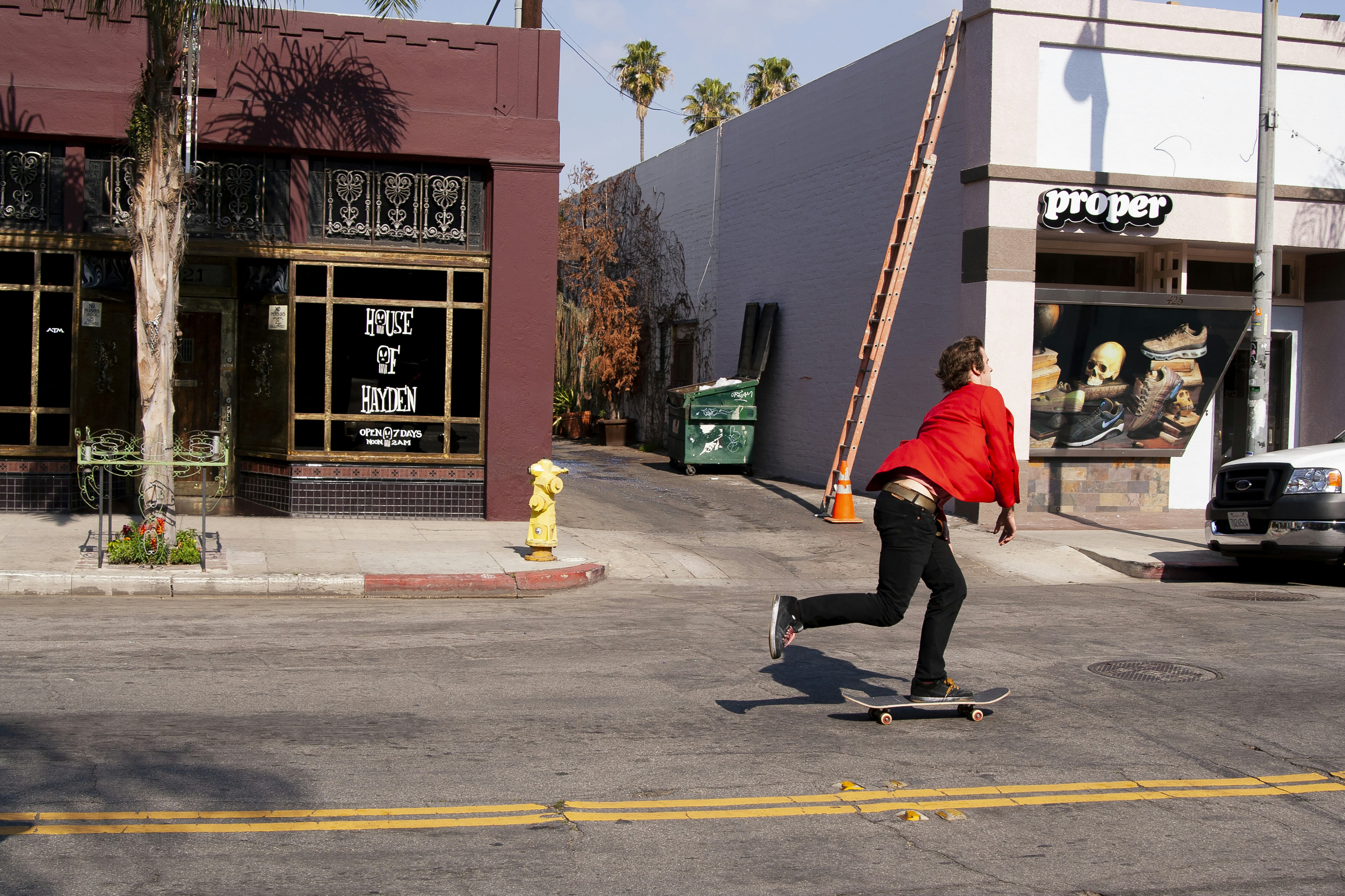 Sunlit Street Glide: A Skater Powers Across a Quiet Downtown Block
