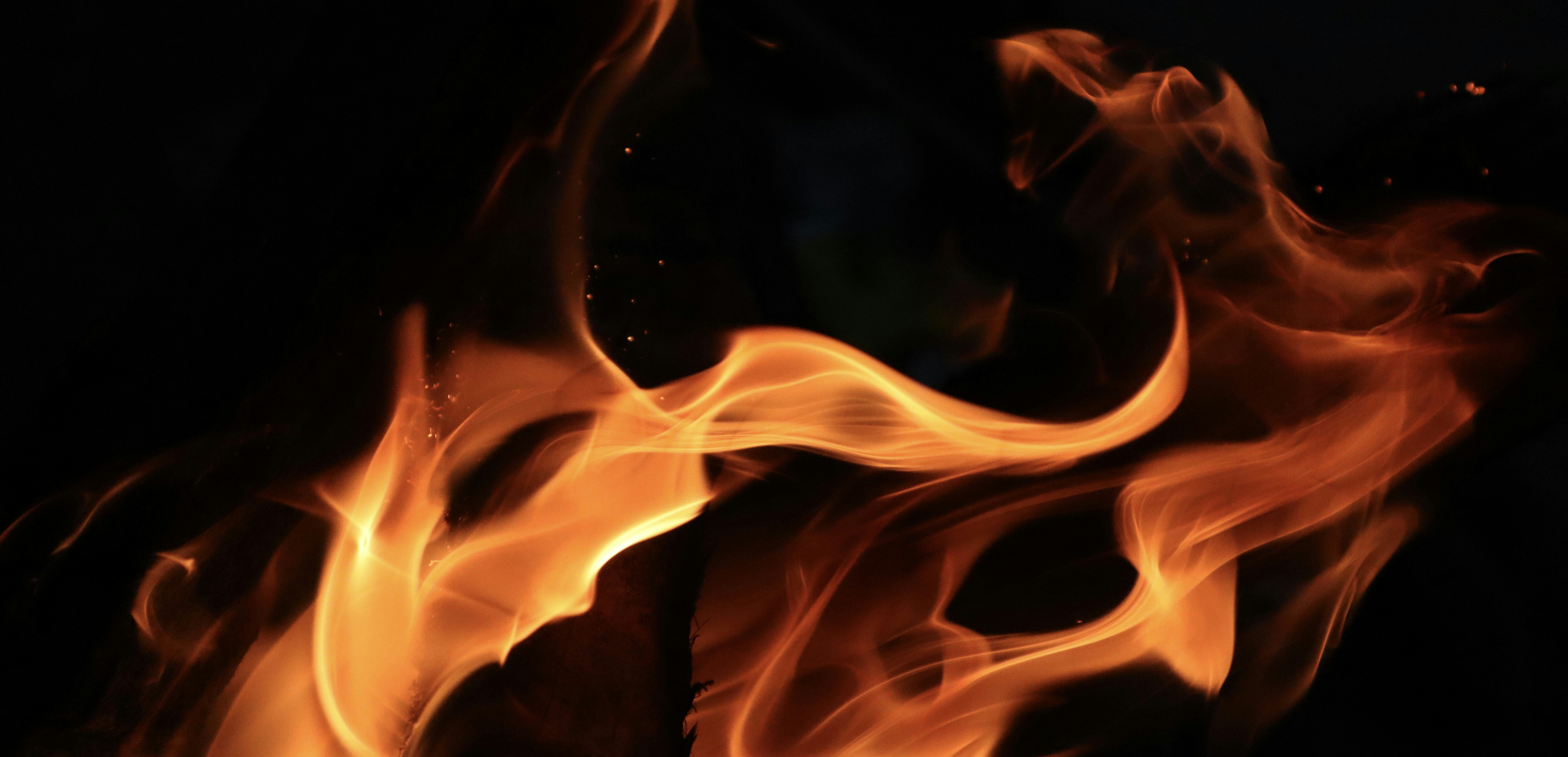 Vivid orange flames swirling against a dark background.