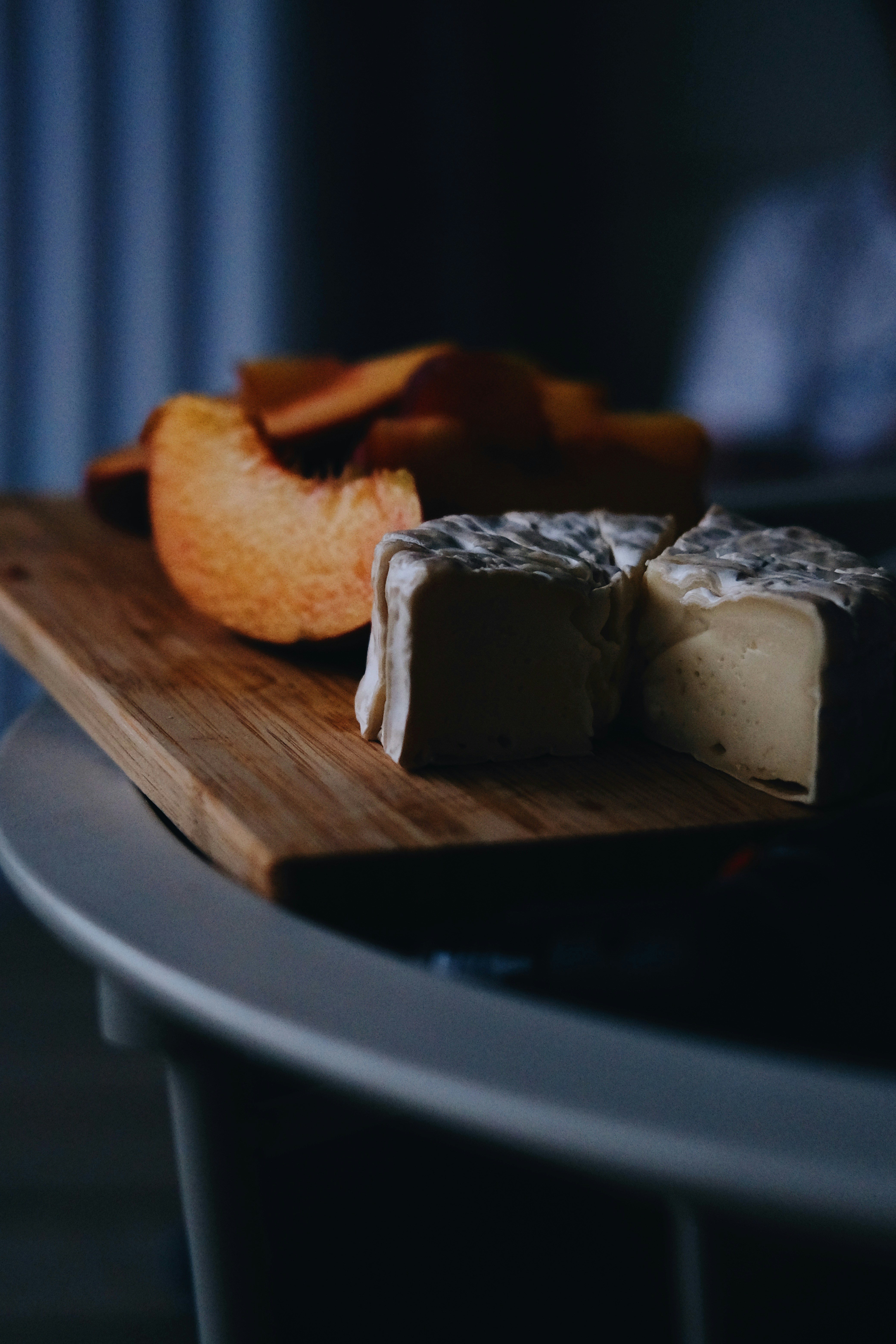 Midnight Brie on a Weathered Board: Quiet Light, Rich Texture