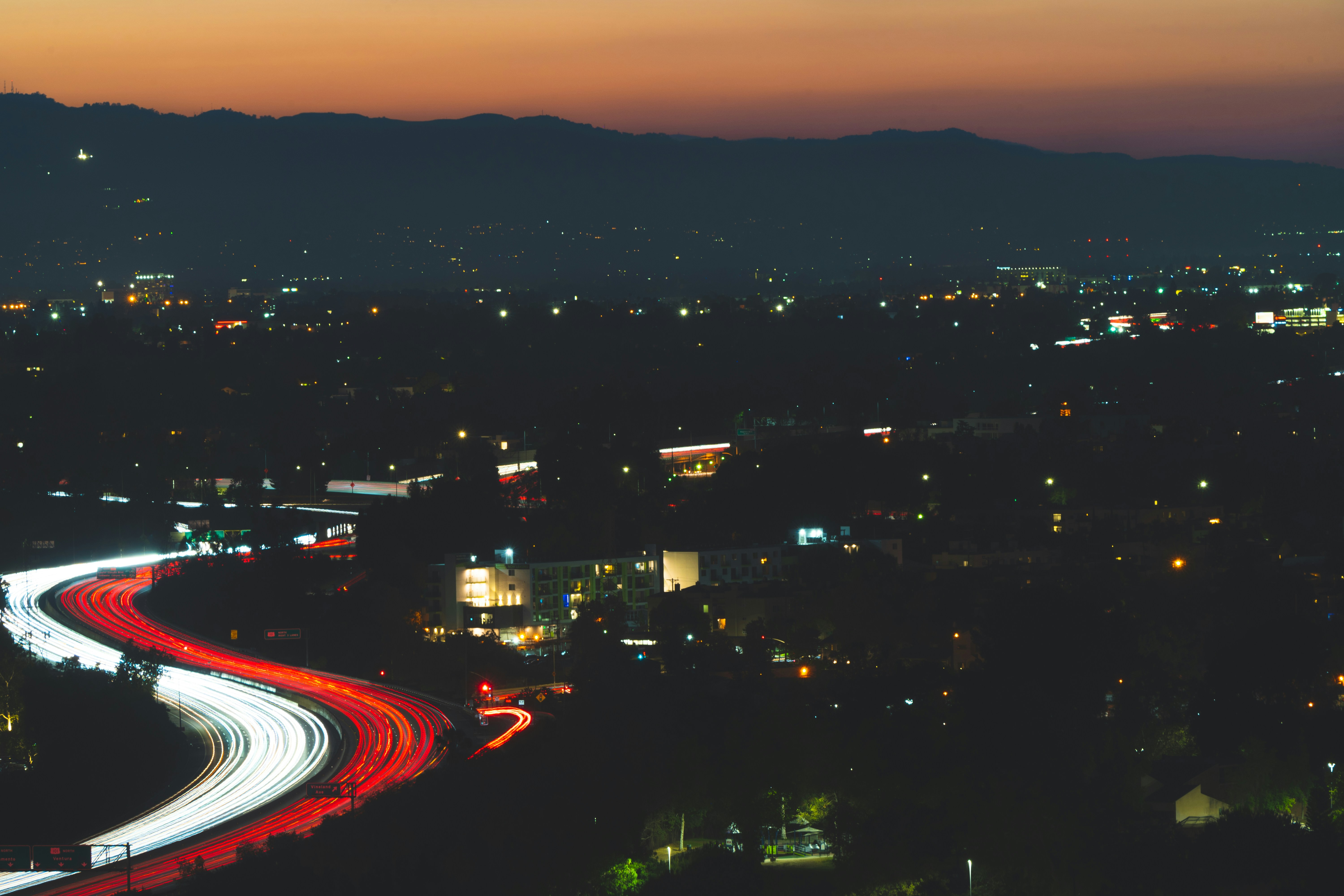 Neon Ribbon over a Sleeping City: Night Highway Light Trails