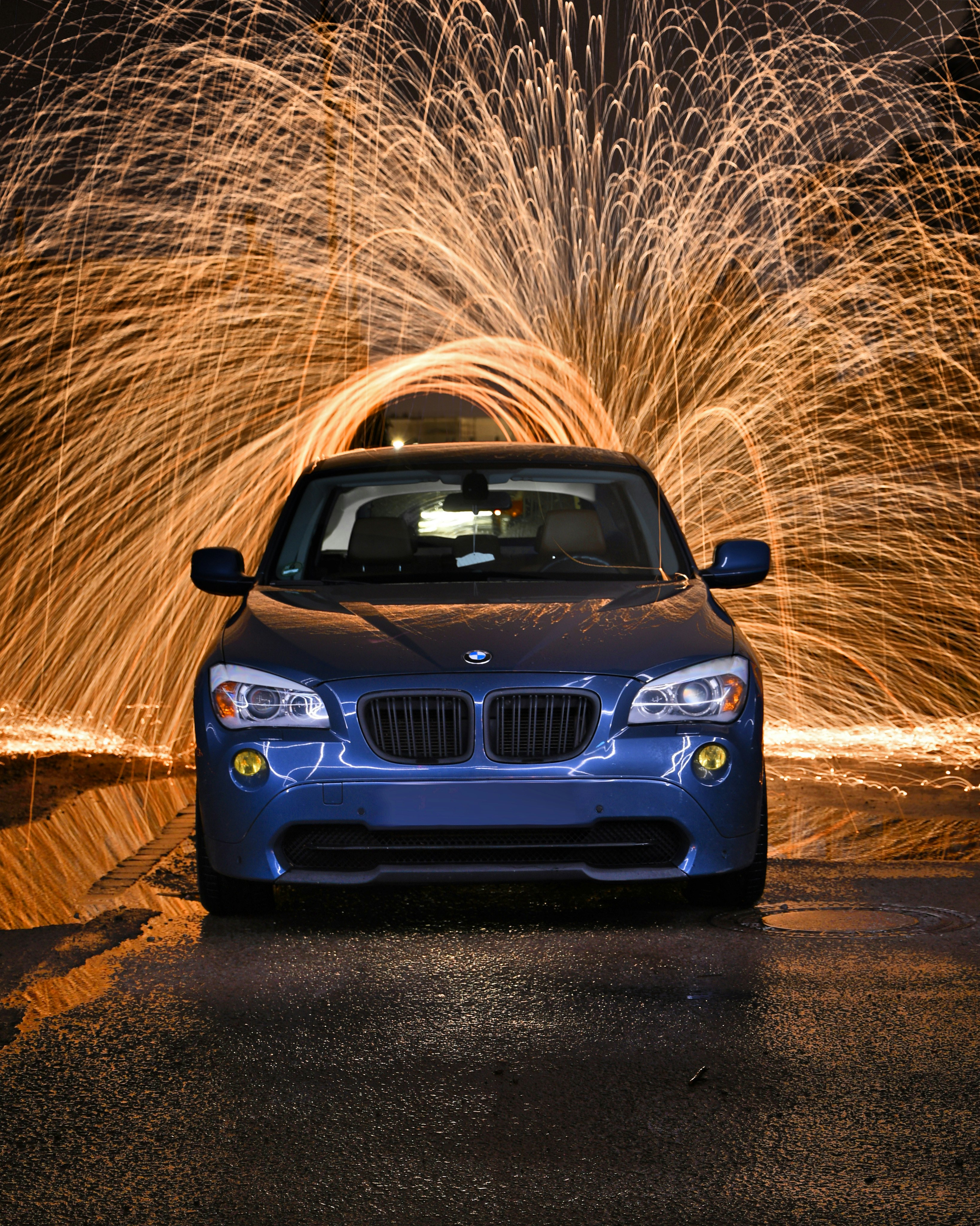 Blue BMW SUV Surrounded by a Fiery Halo of Sparks