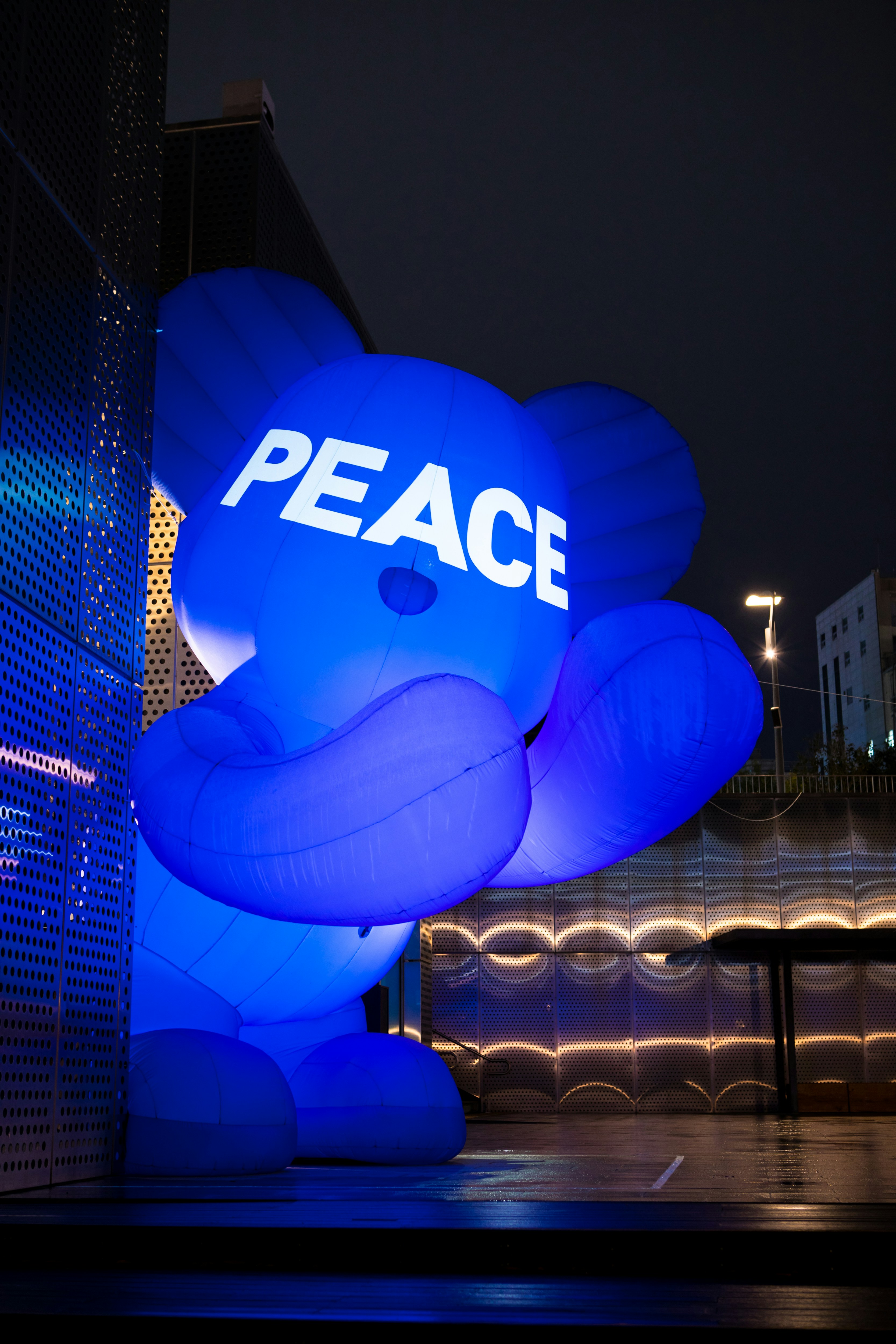 Neon Peace Orbs: Night Installation of Blue Inflatable Sculptures