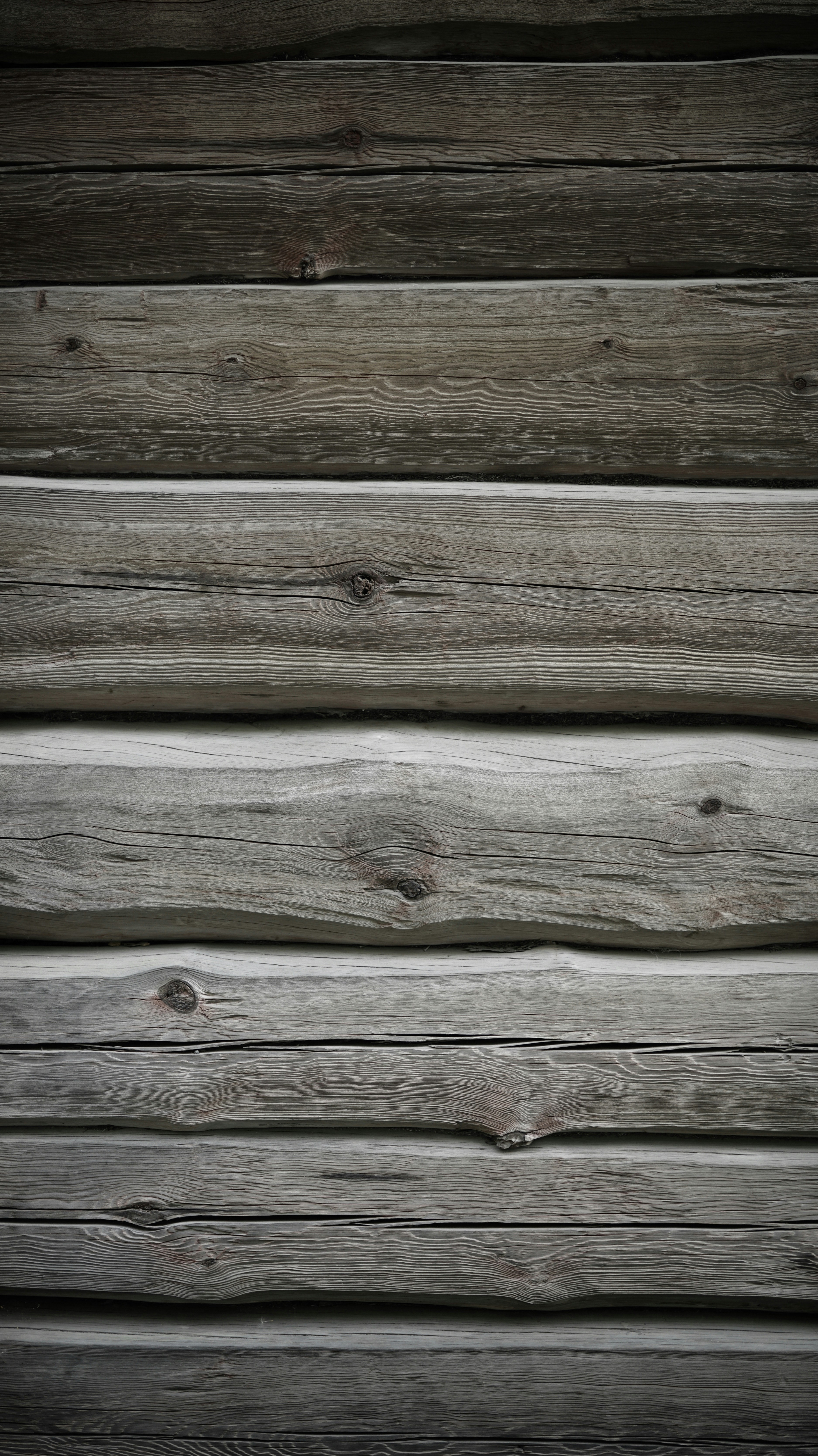Close-up of weathered wooden planks showcasing intricate grain patterns and textures.