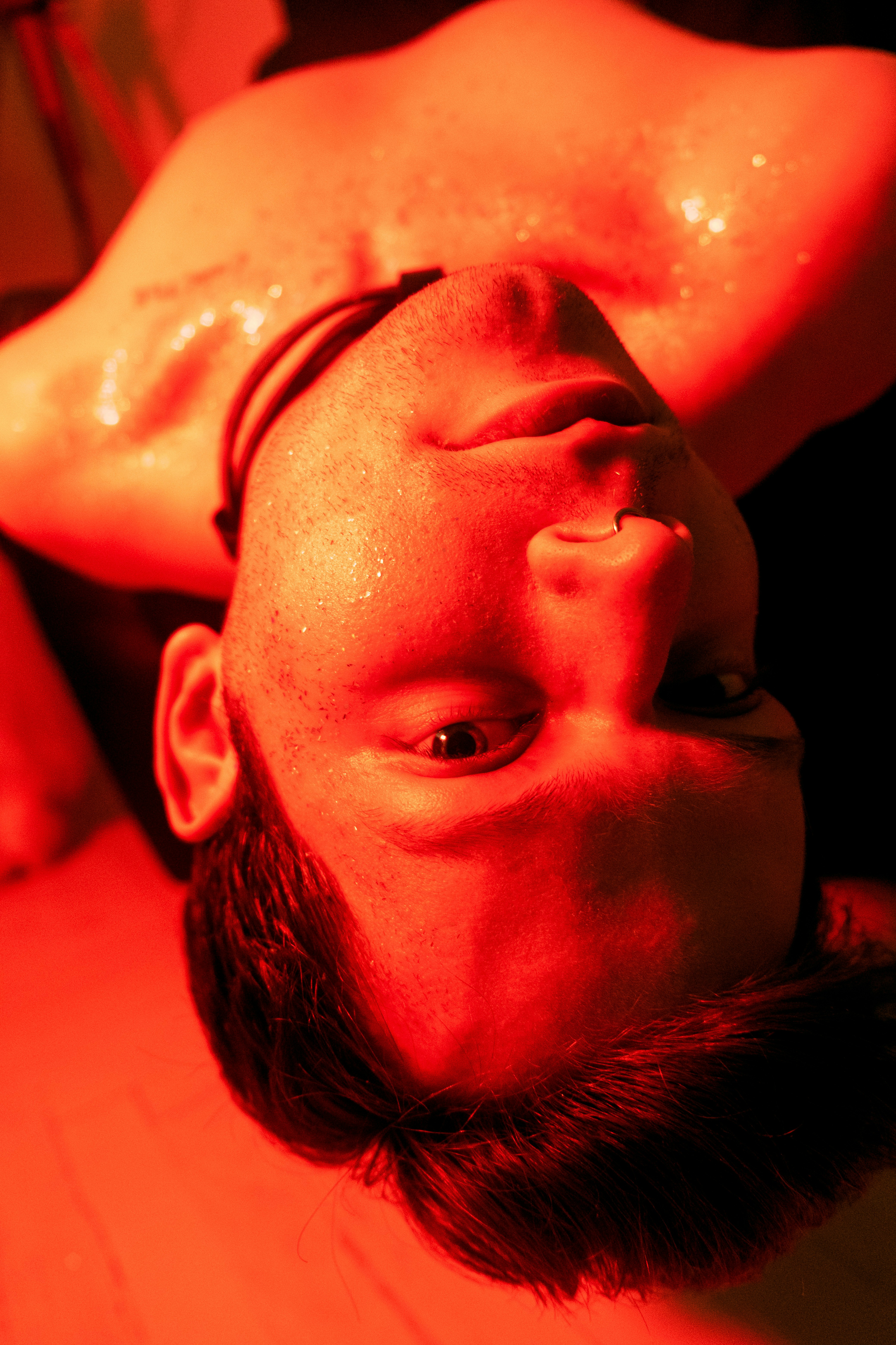 man lying on bed with water droplets